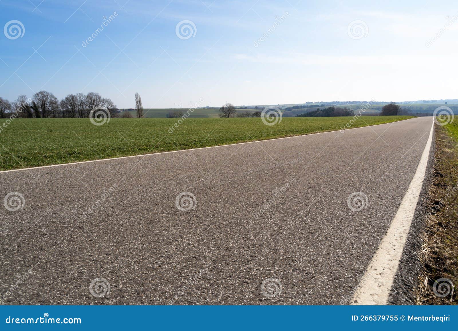 Low Angle View of a Paved Rural Road in the Landscape with Blue Sunny ...