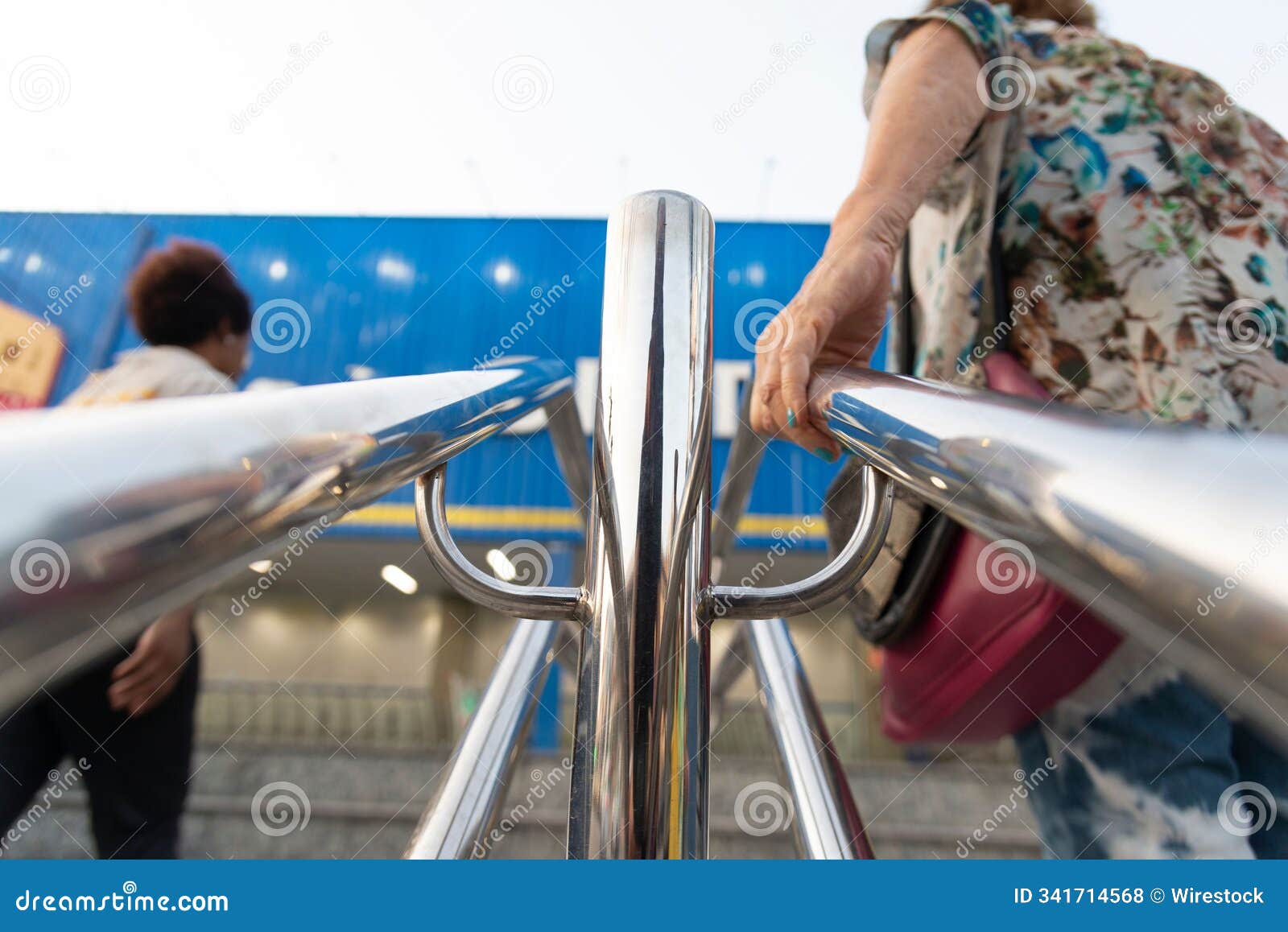 Low Angle View of People Walking Up Stairs with Focus on Handrail ...