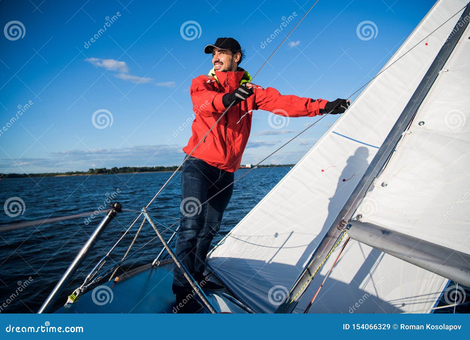 Low Angle View of Sailor Operating Windlass on Yacht. Working with ...