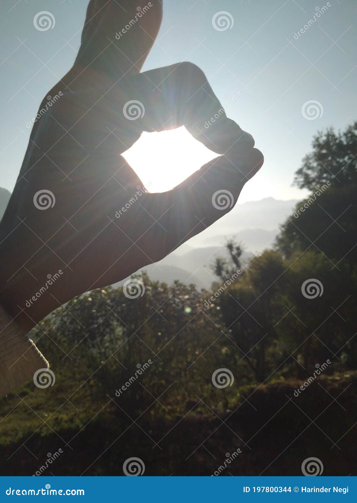 Low Angle View of Silhouette Hand Holding Sun during Sunset Stock Photo ...