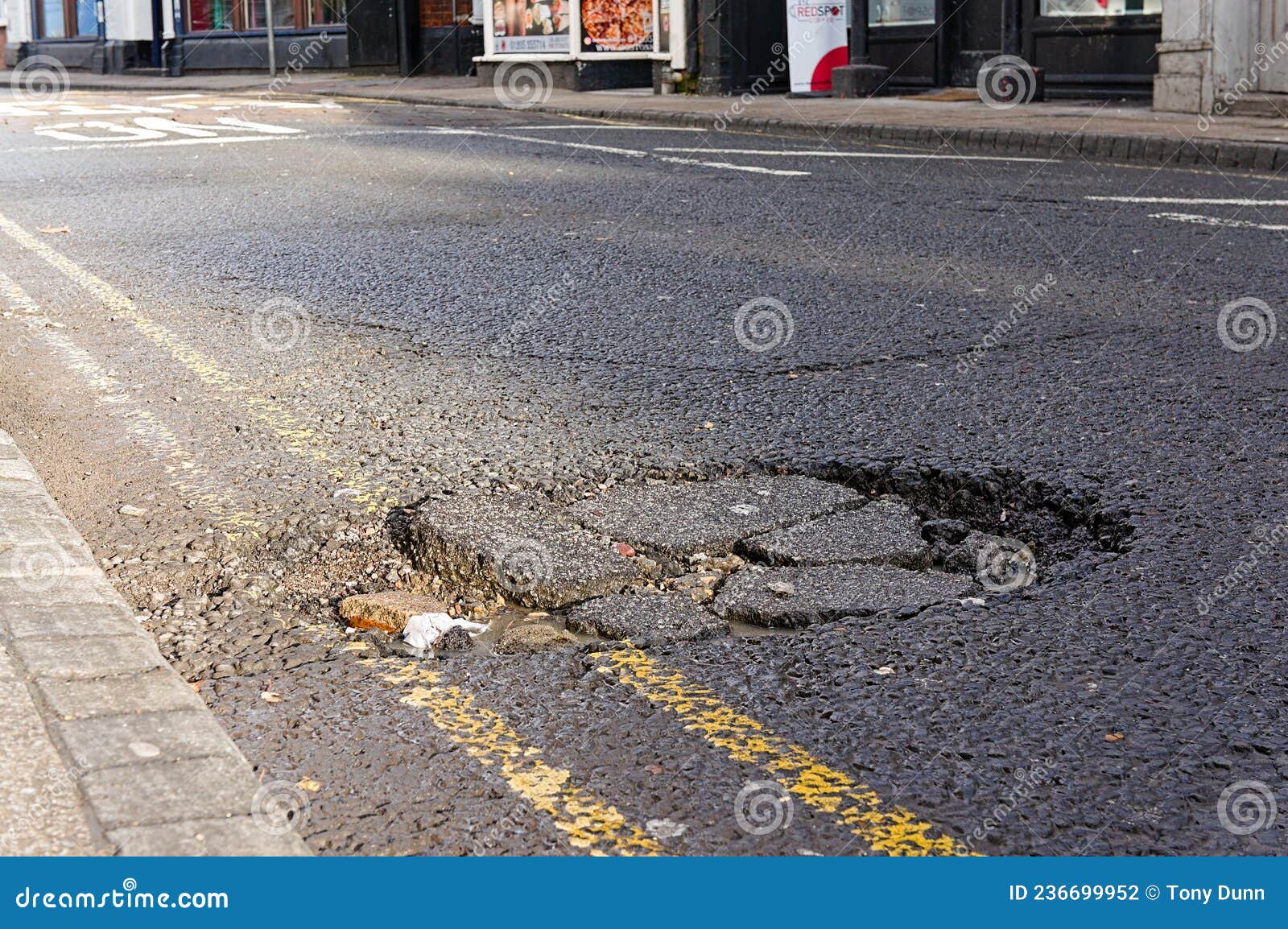 Large Pothole in a Tarmac Road Stock Photo - Image of angle, yellow ...