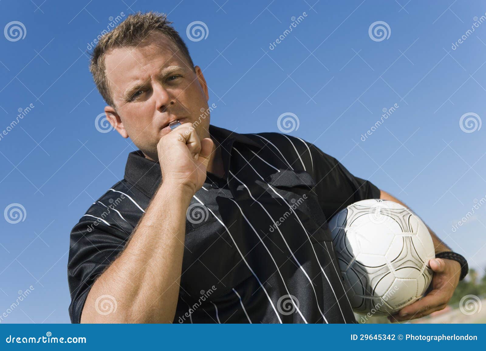 Low Angle View of Soccer Referee Showing Yellow Card Against Blue Sky ...