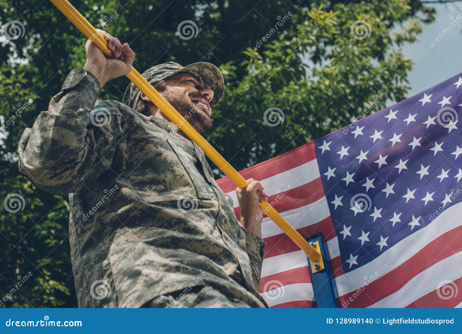Low Angle View of Soldier Pulling Himself Up on Crossbar with American ...