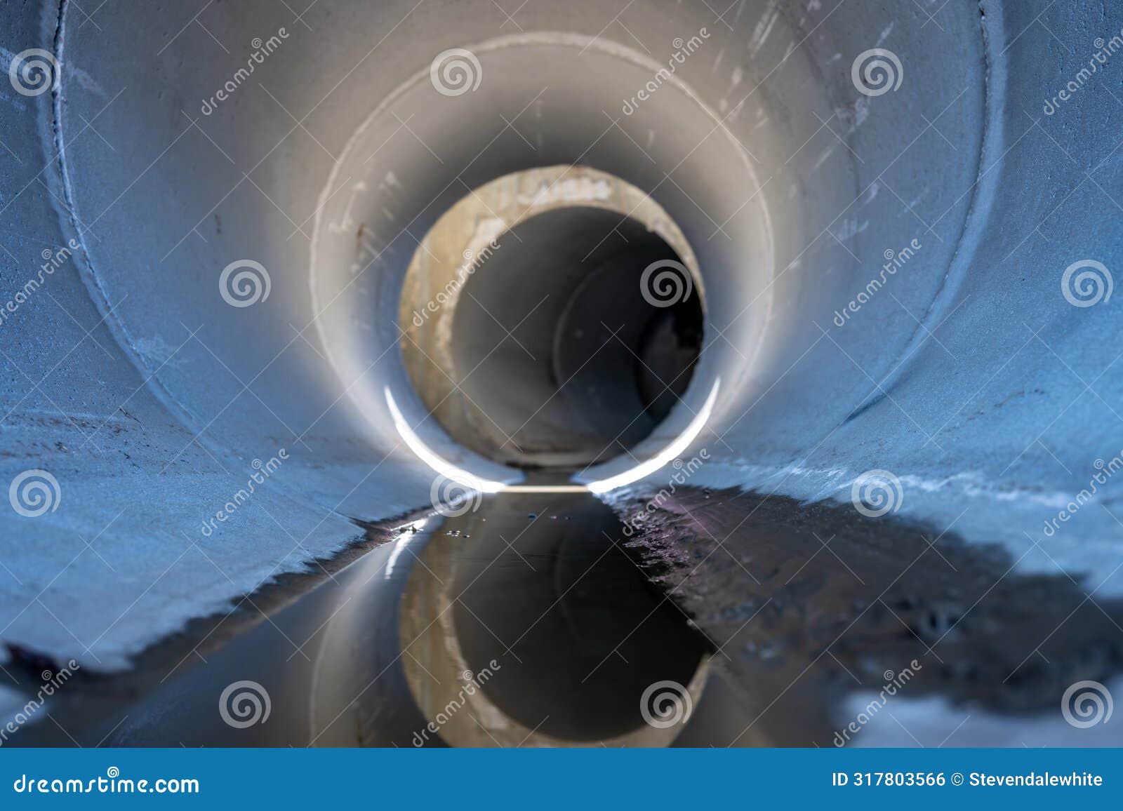 Low Angle View of Stormwater Trickling through a Large Concrete Culvert ...