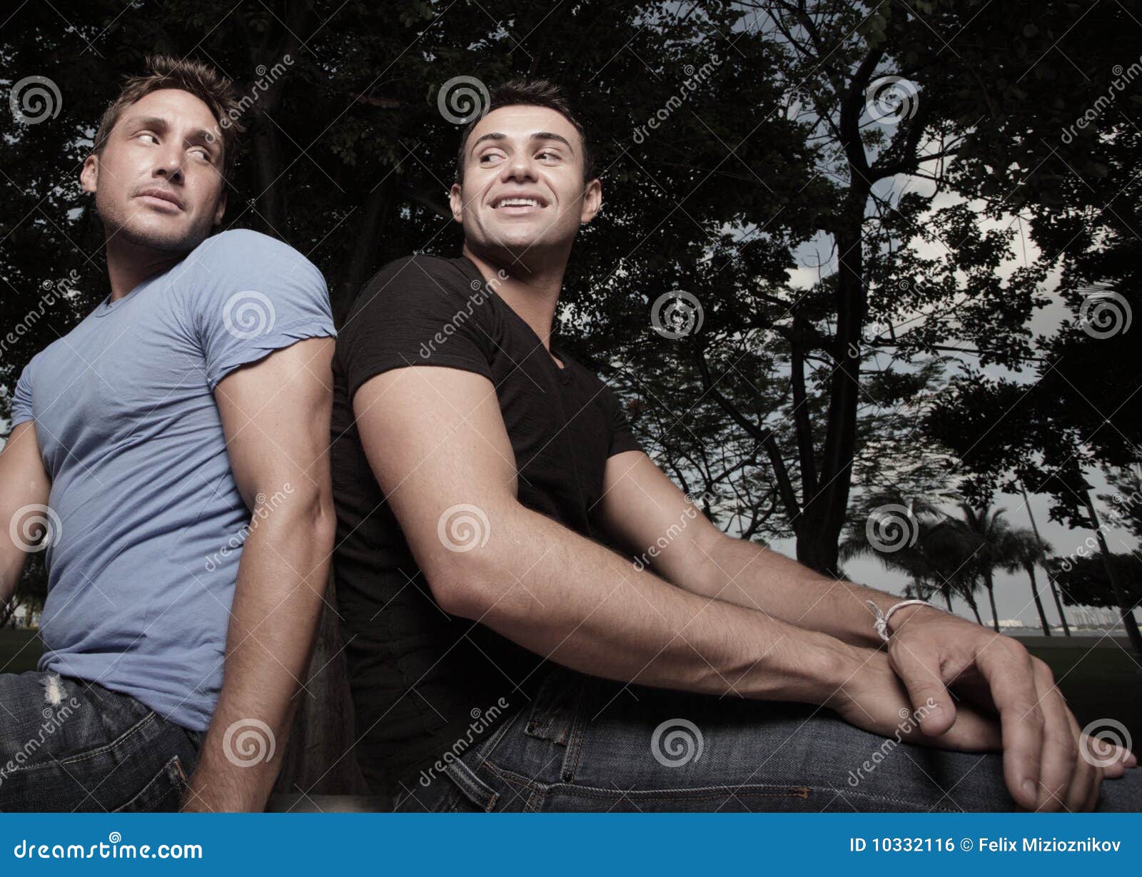 Low Angle View of Two Men Sitting Stock Photo - Image of friends ...