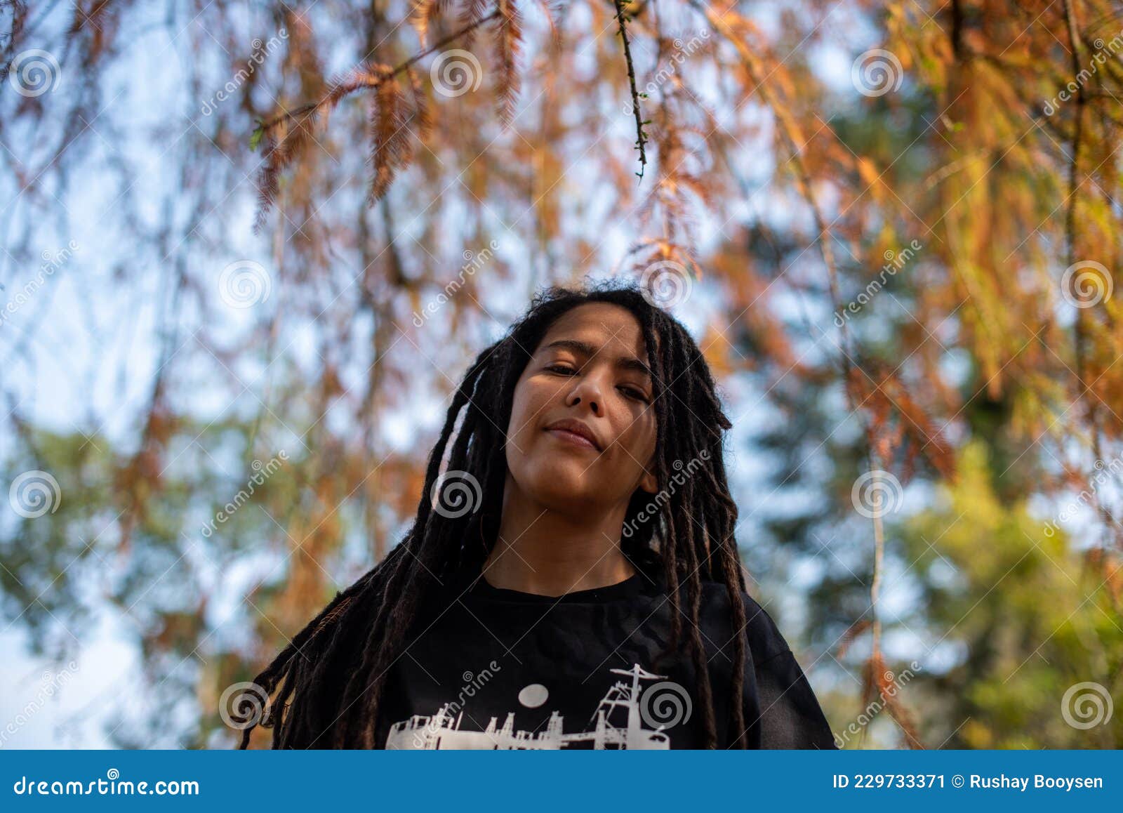 Low Angle View of Woman with Locs Staring Down at the Camera Stock ...