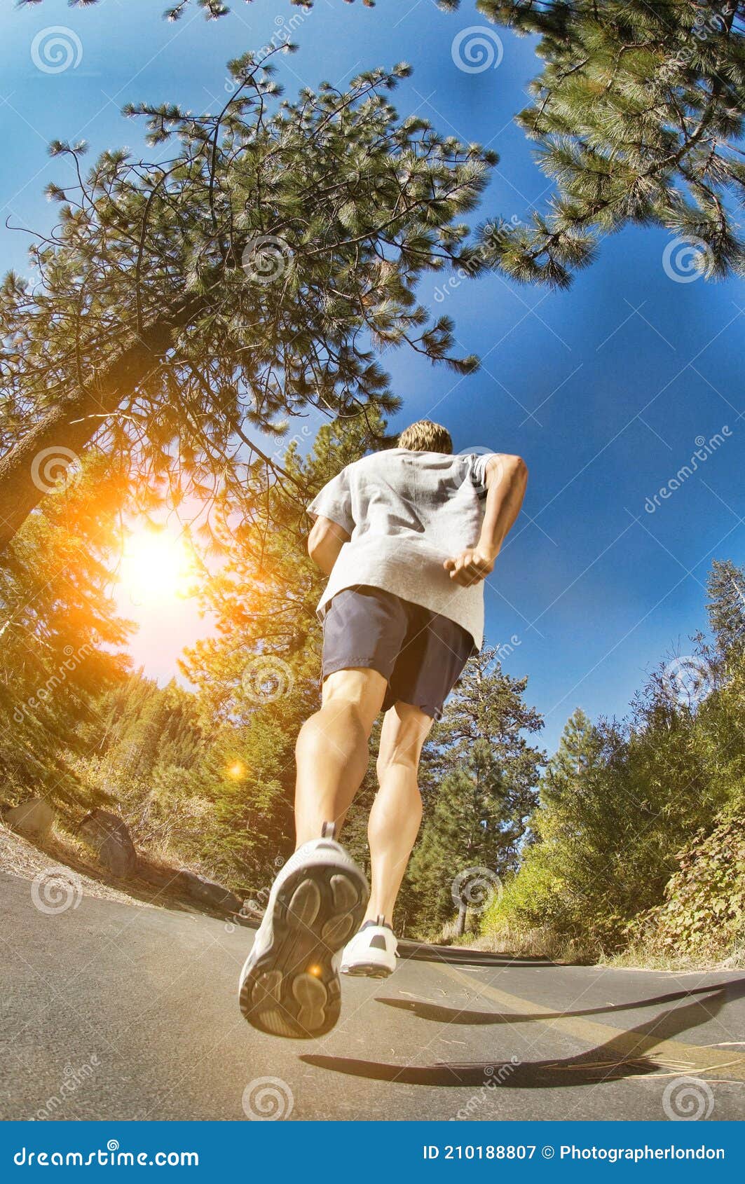 Low Angle View of Young Man Jogging on Road Stock Image - Image of ...