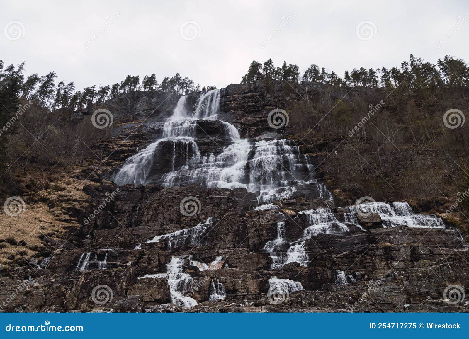Low-angle of a Waterfall Flowing Downstream on a Rocky Cliff Stock ...