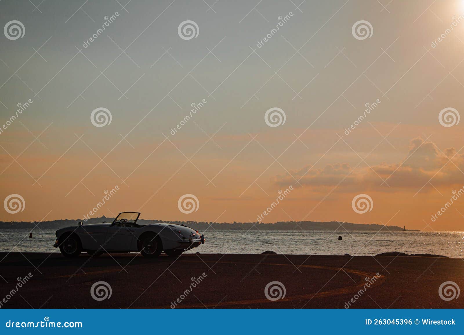 Low-angle of a White Austin Healey on the Beach at Sunset Golden Purple ...