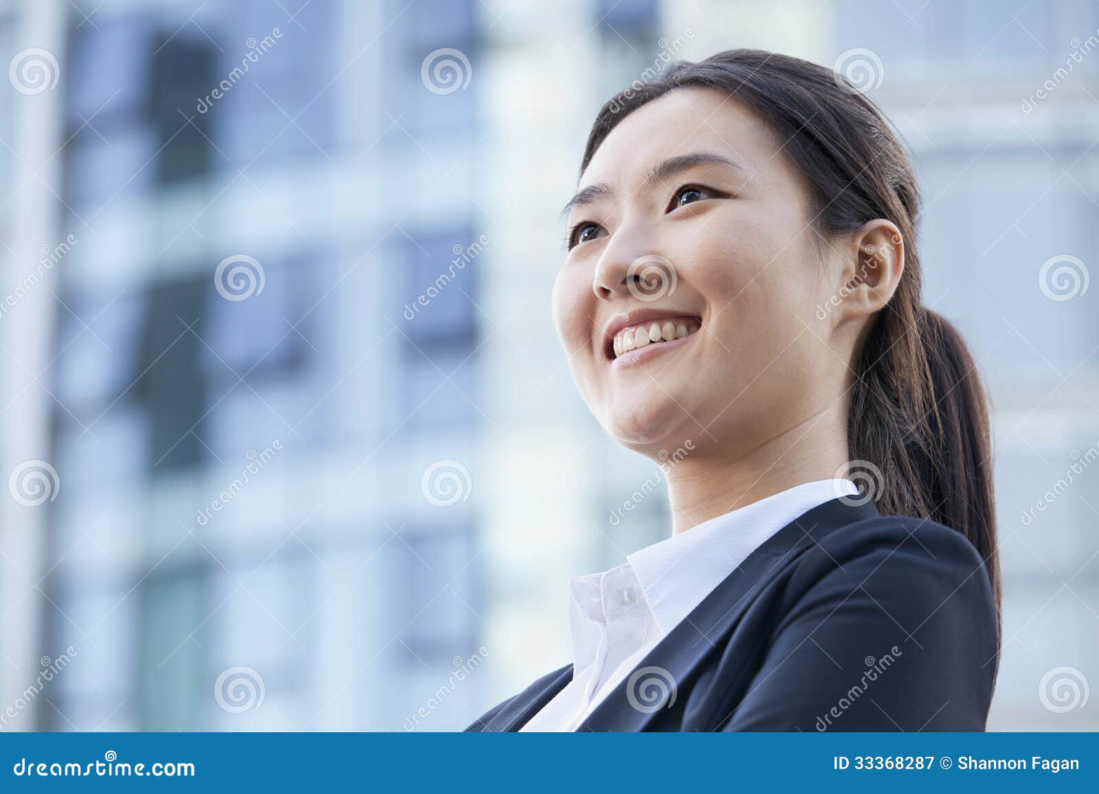 Low Angle of a Young Businesswoman Smiling Stock Image - Image of ...