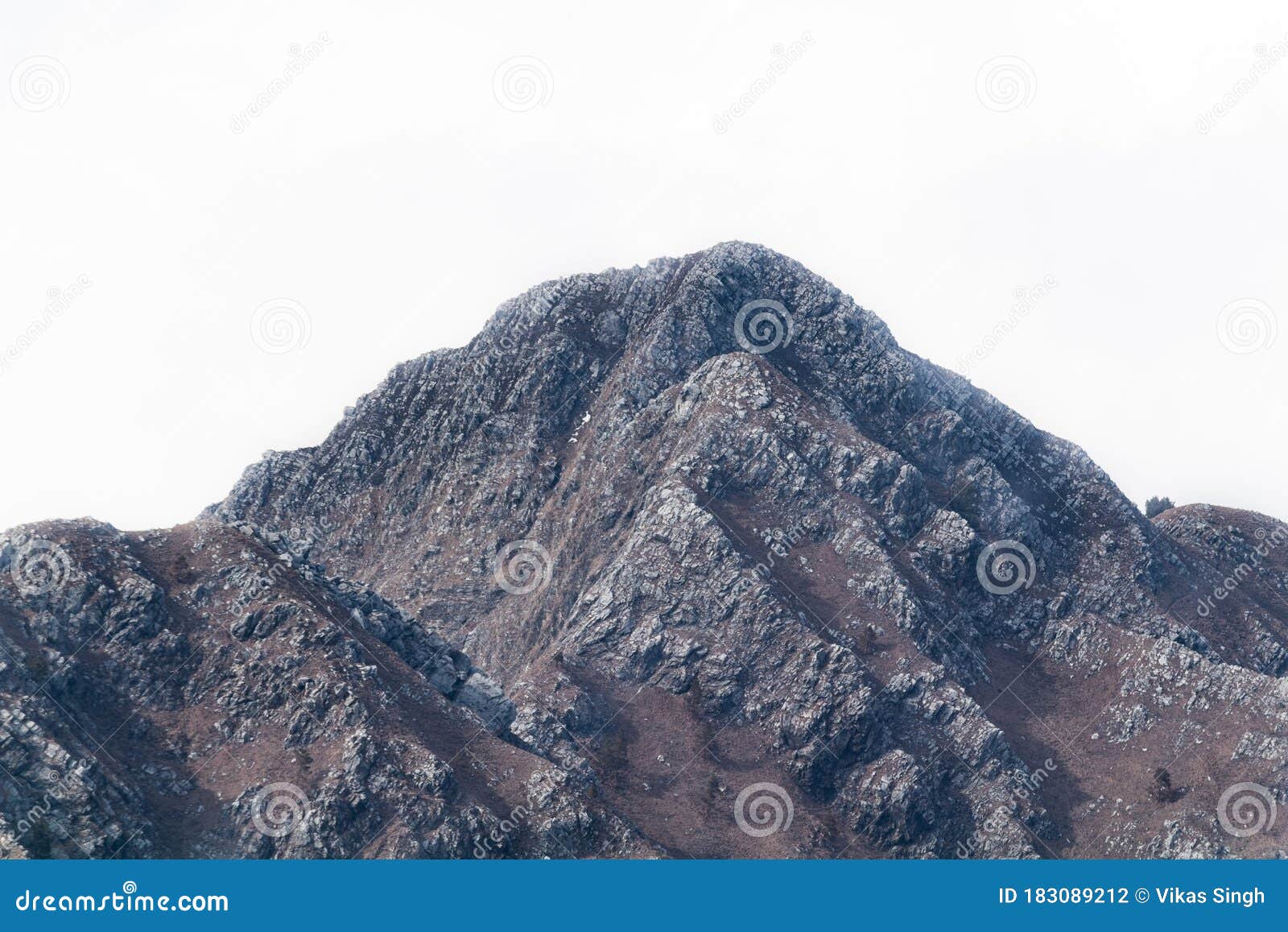 Low Angle Zoom in Shot of a Mountain Peak with Bright Sky in the ...