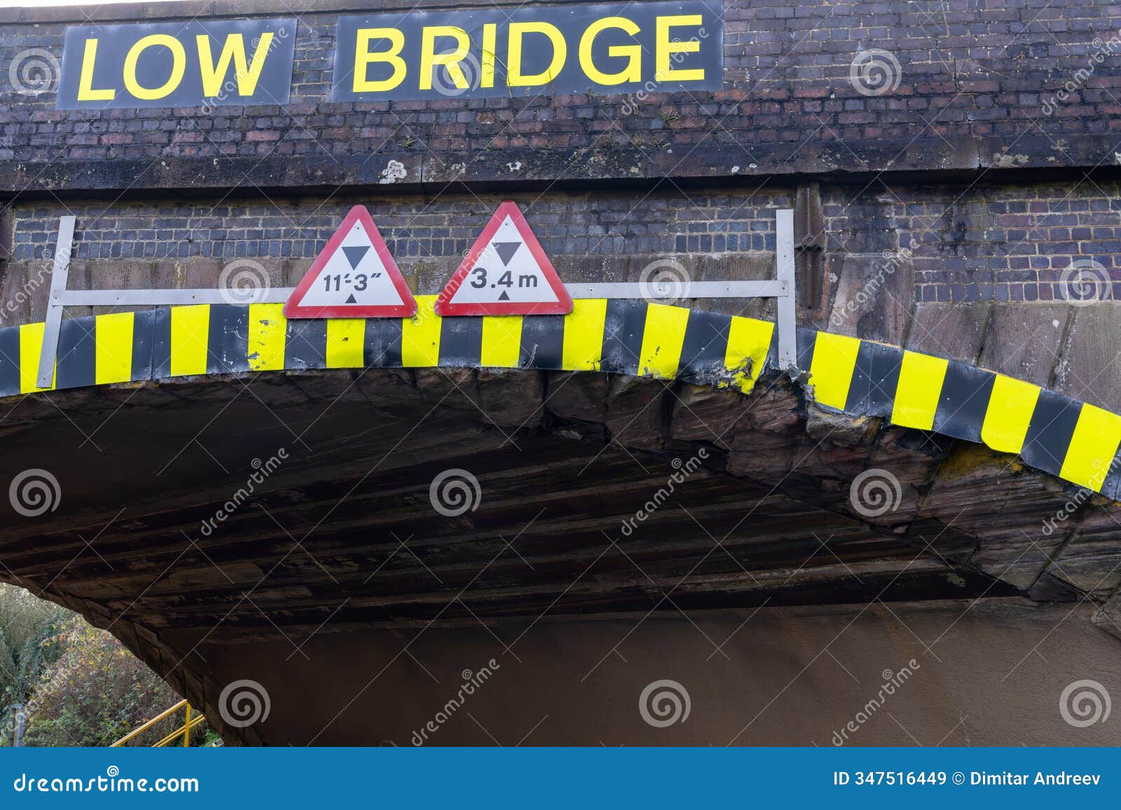 Low Bridge Warning Sign Showing Height Restriction and Damaged ...