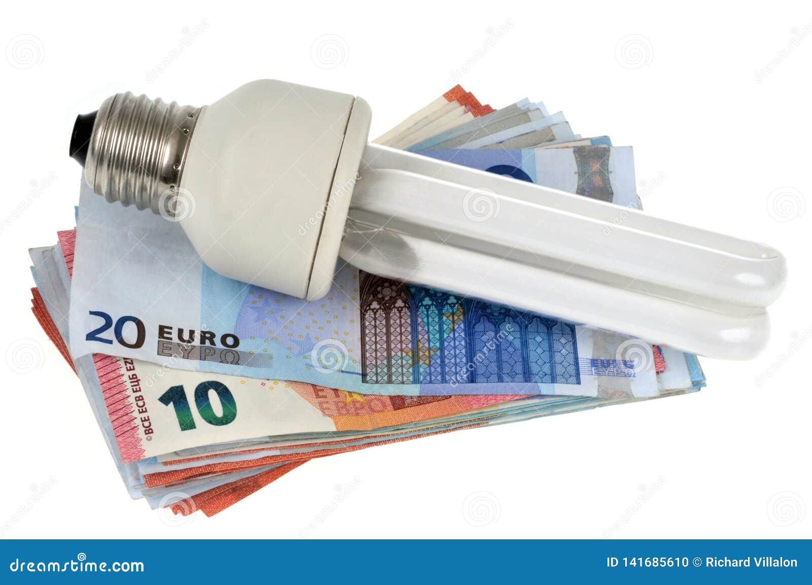 Low Consumption Light Bulb Placed on a Wad of Banknotes Stock Photo ...