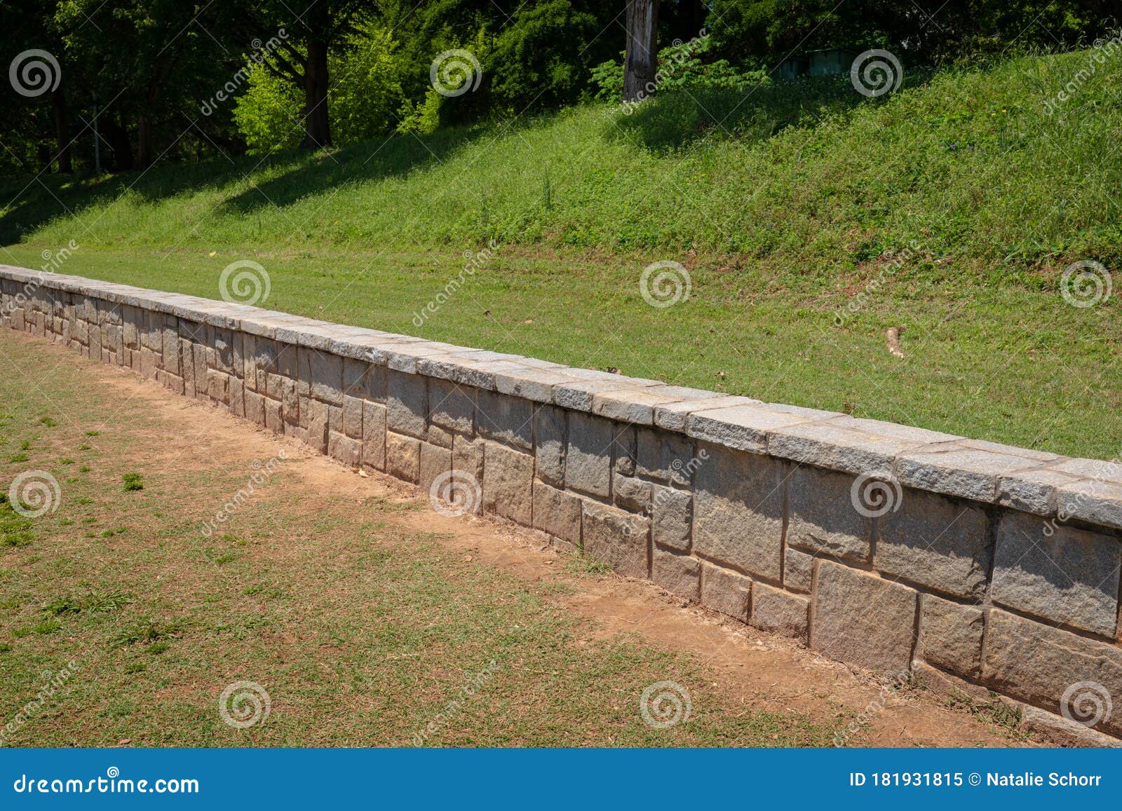 Low Granite Block Retaining Wall in an Urban Park, Green Grass and ...