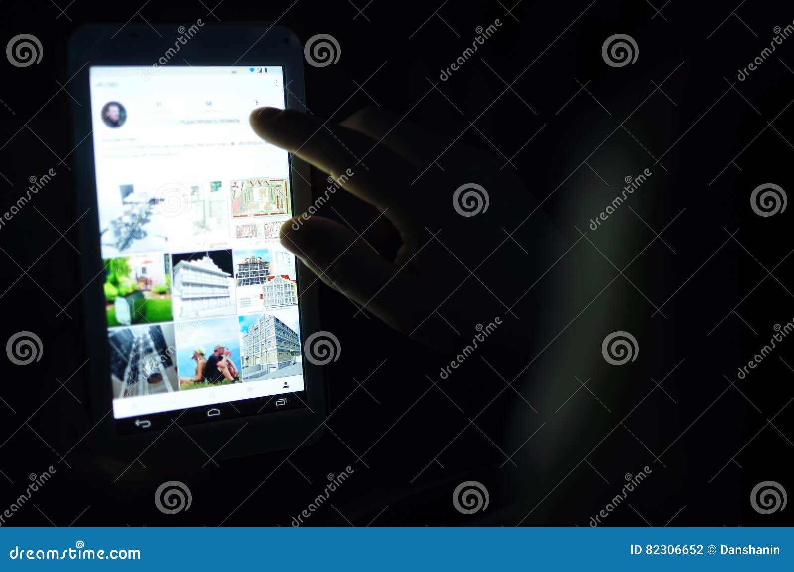 Low Key Image of Man Using Instagram Application on His Touch Pad ...