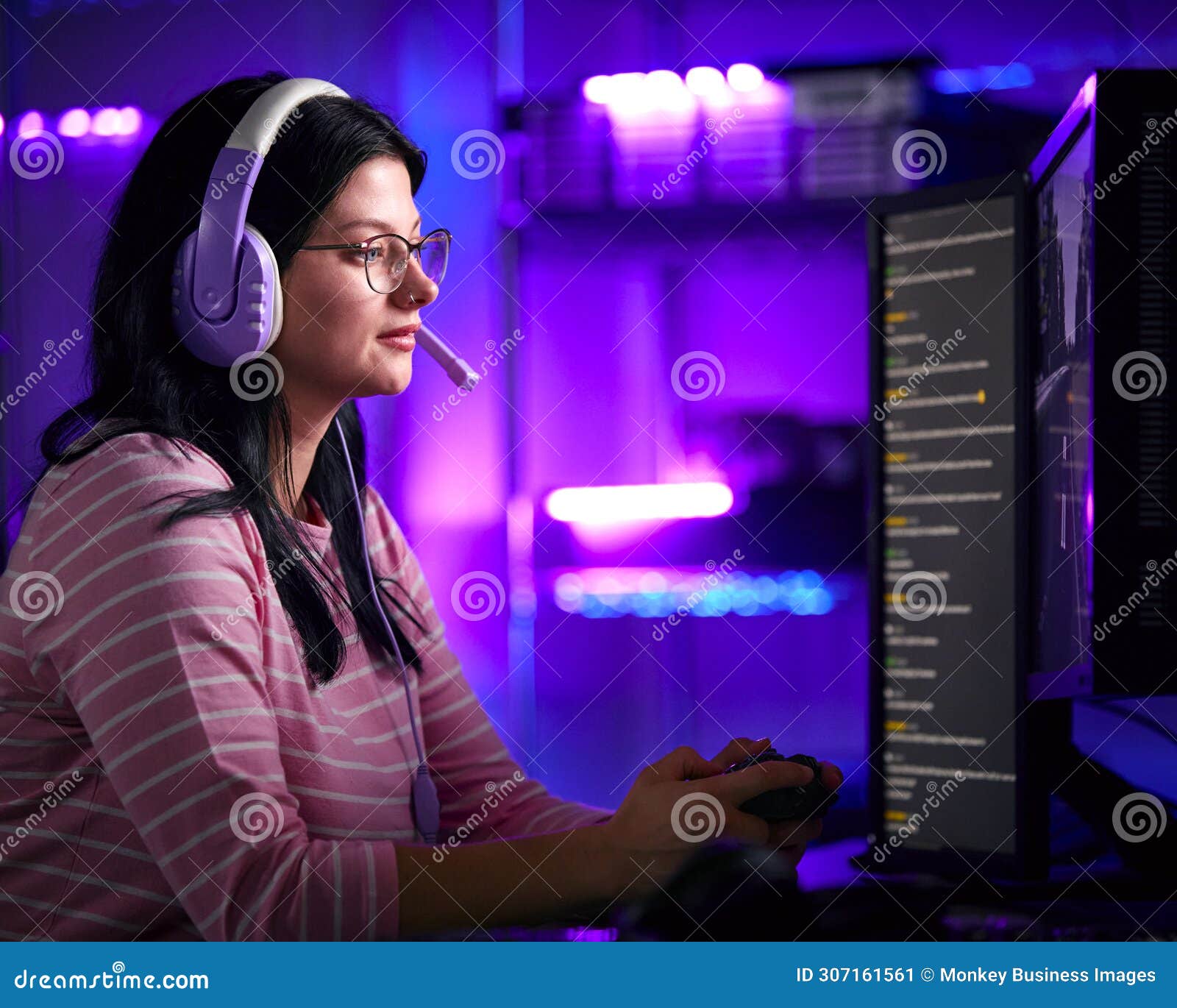 Low Key Lighting Shot of Female Gamer in Front of Computer Screens with ...