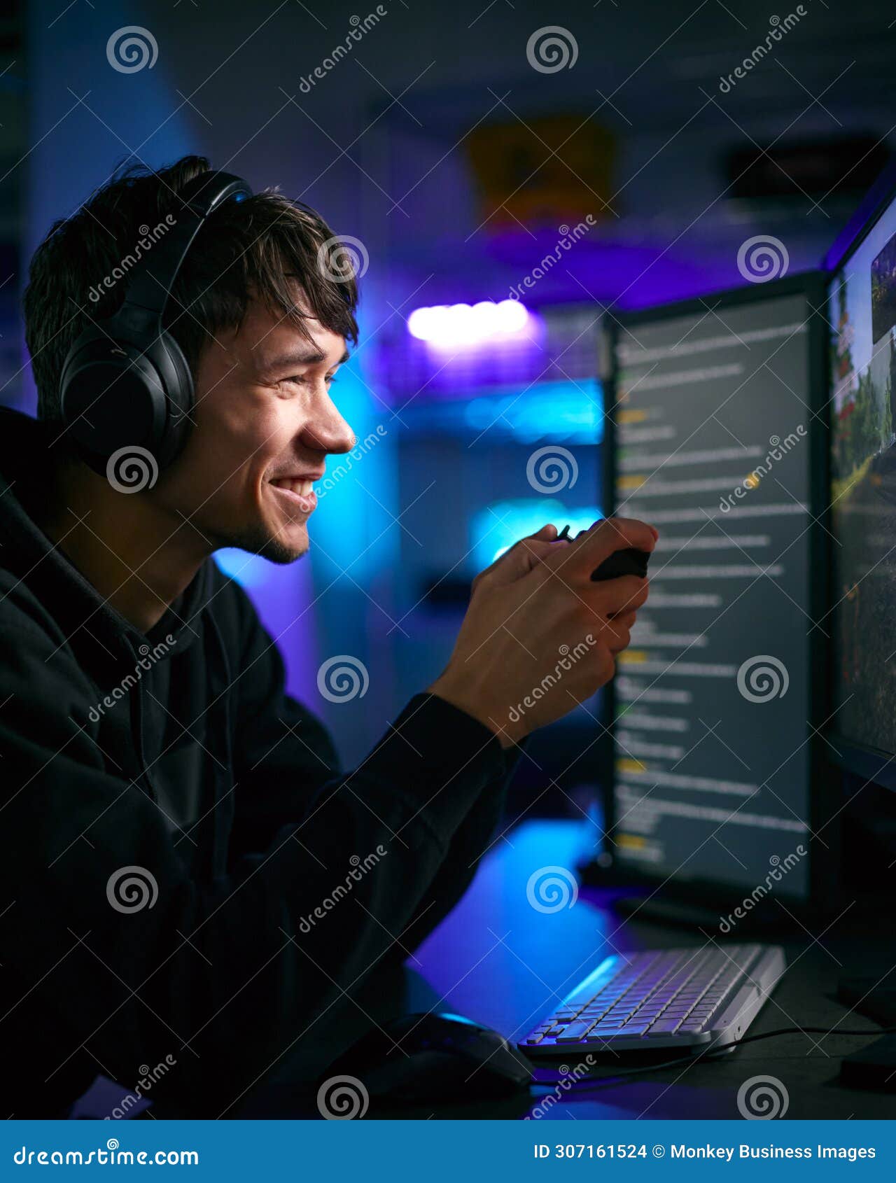 Low Key Lighting Shot of Male Gamer in Front of Computer Screens with ...