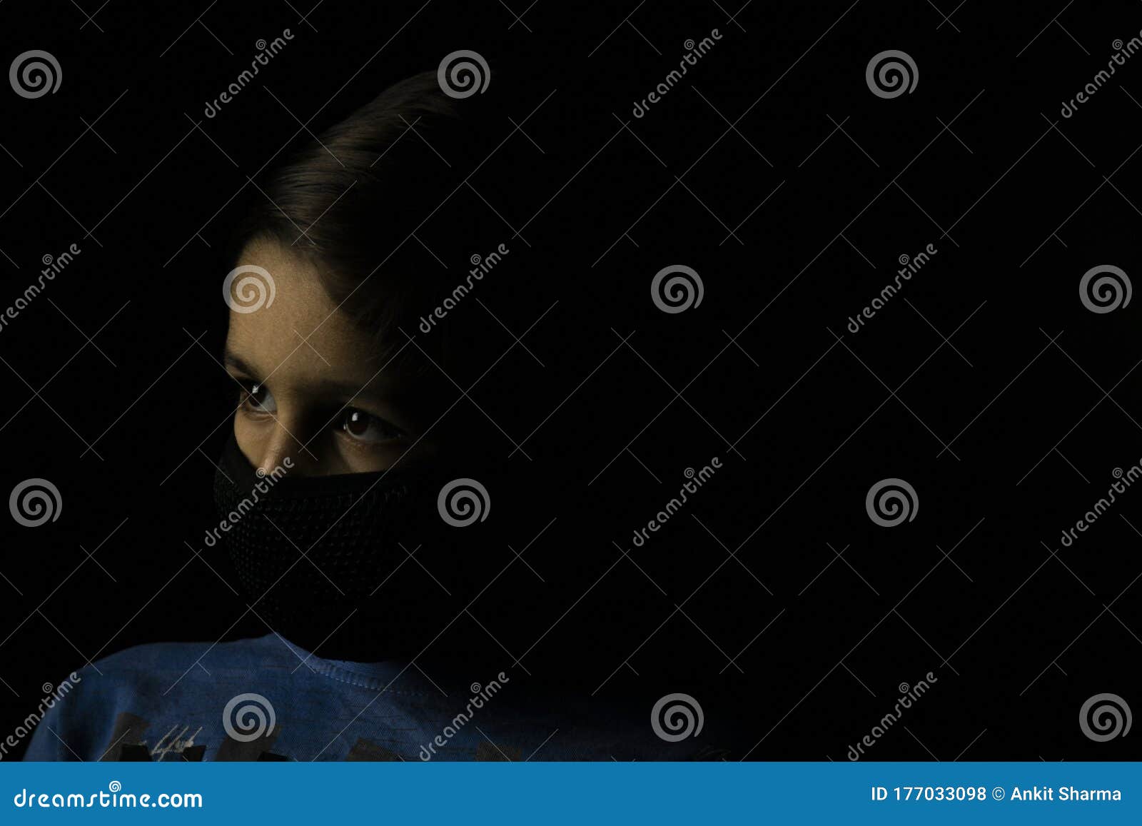 Low Key Photography of Child with Mask on Face with a Space for Text ...