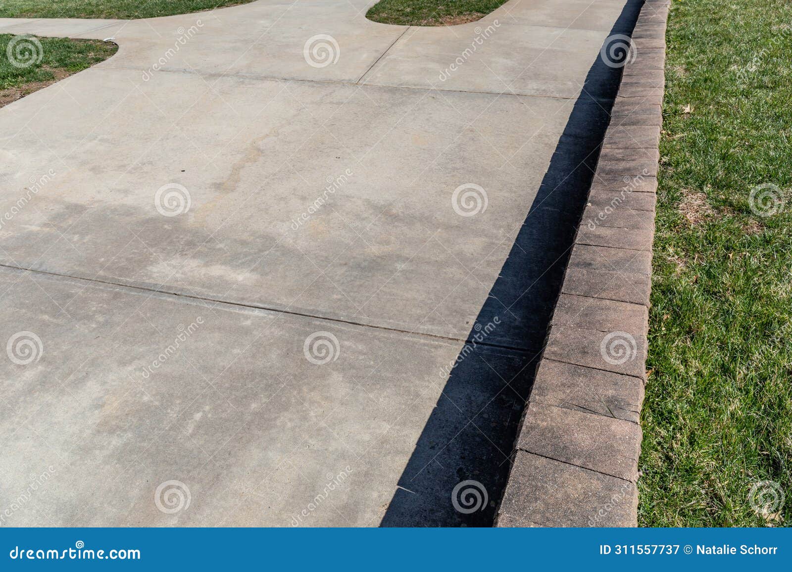 Low Retaining Wall beside a Broad Concrete Walkway, Creative Copy Space ...