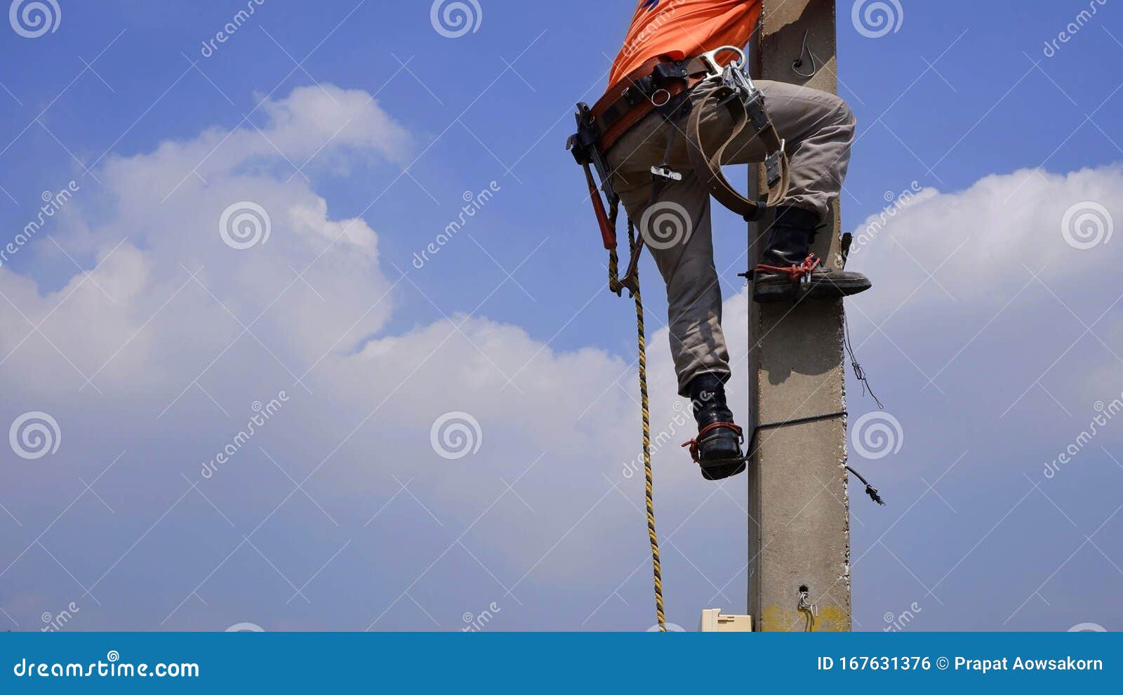 Electrical Lineman Connecting Wires High On Electric Pole. Powerline ...