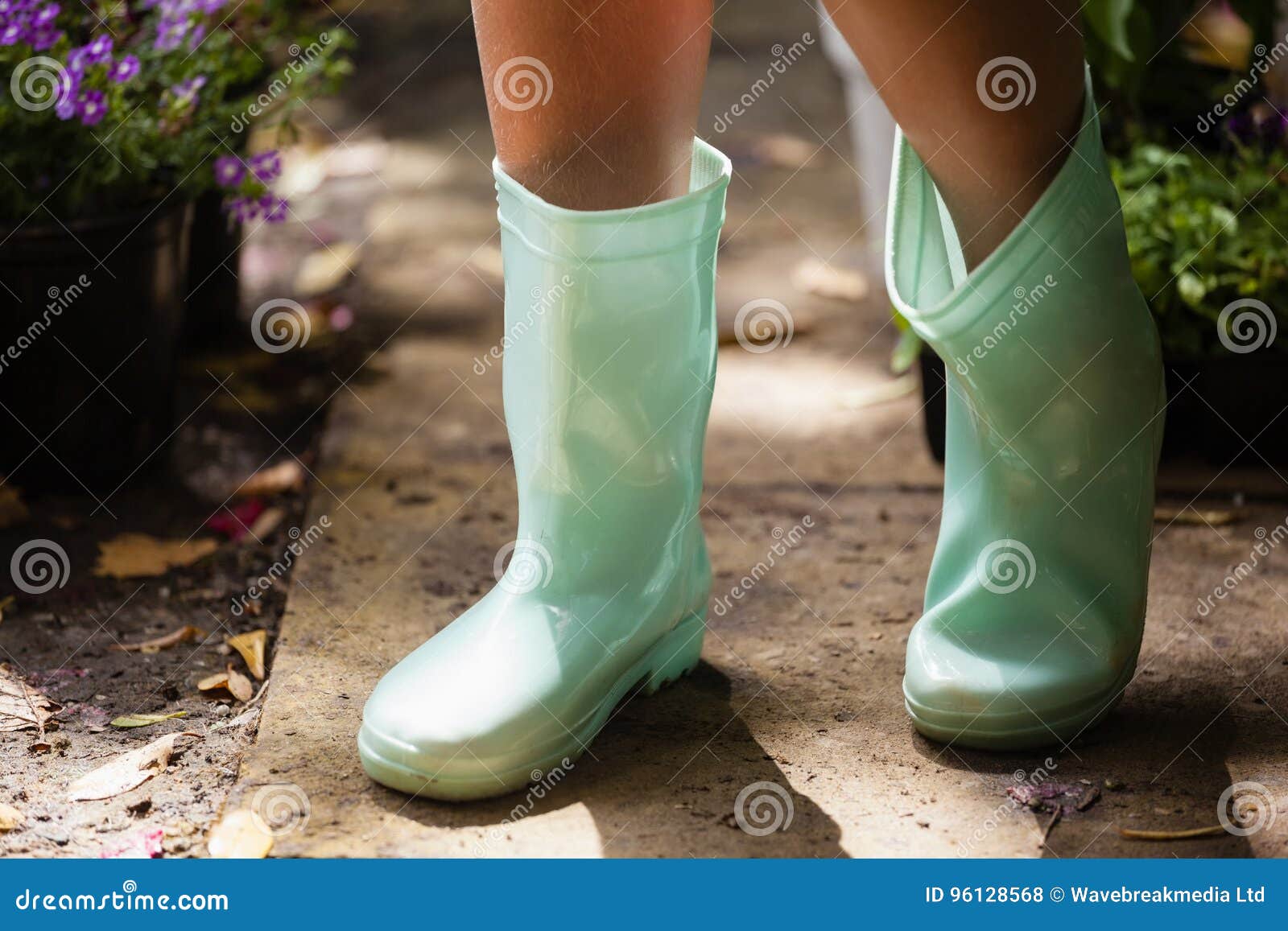 Low Section of Girl Wearing Green Rubber Boot Standing on Footpath ...