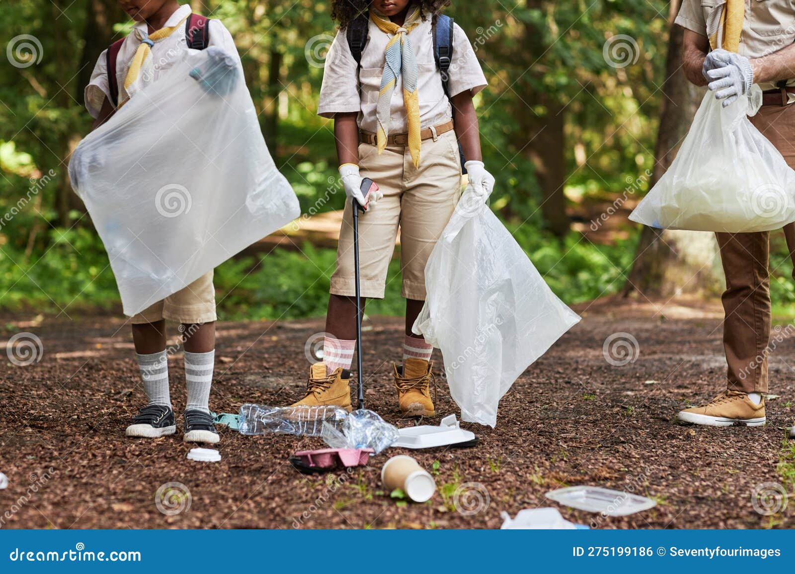 Low Section of Group of Scouts Picking Up Trash in Forest Stock Photo ...