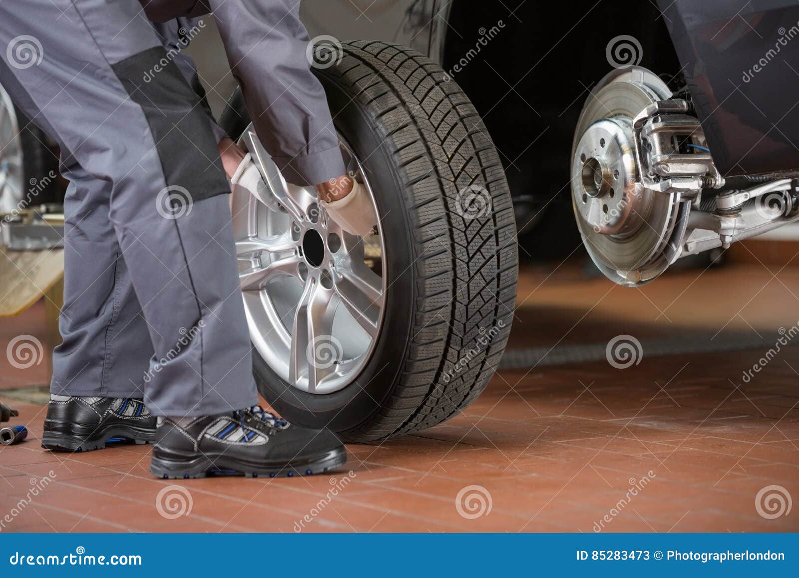 Low Section of Repairman Fixing Car S Tire in Repair Shop Editorial ...