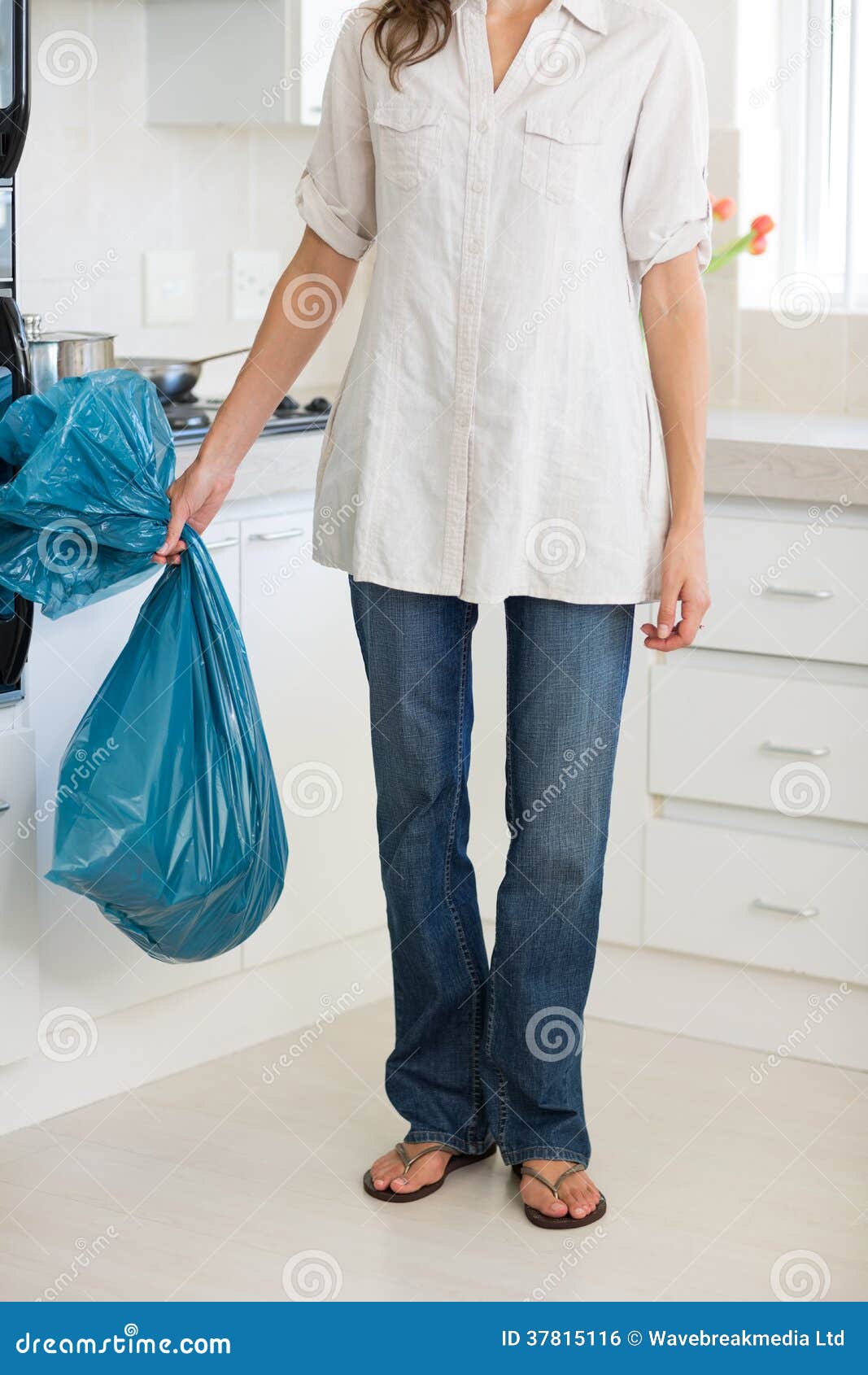 Low Section of Woman Carrying Garbage Bag in Kitchen Stock Photo ...
