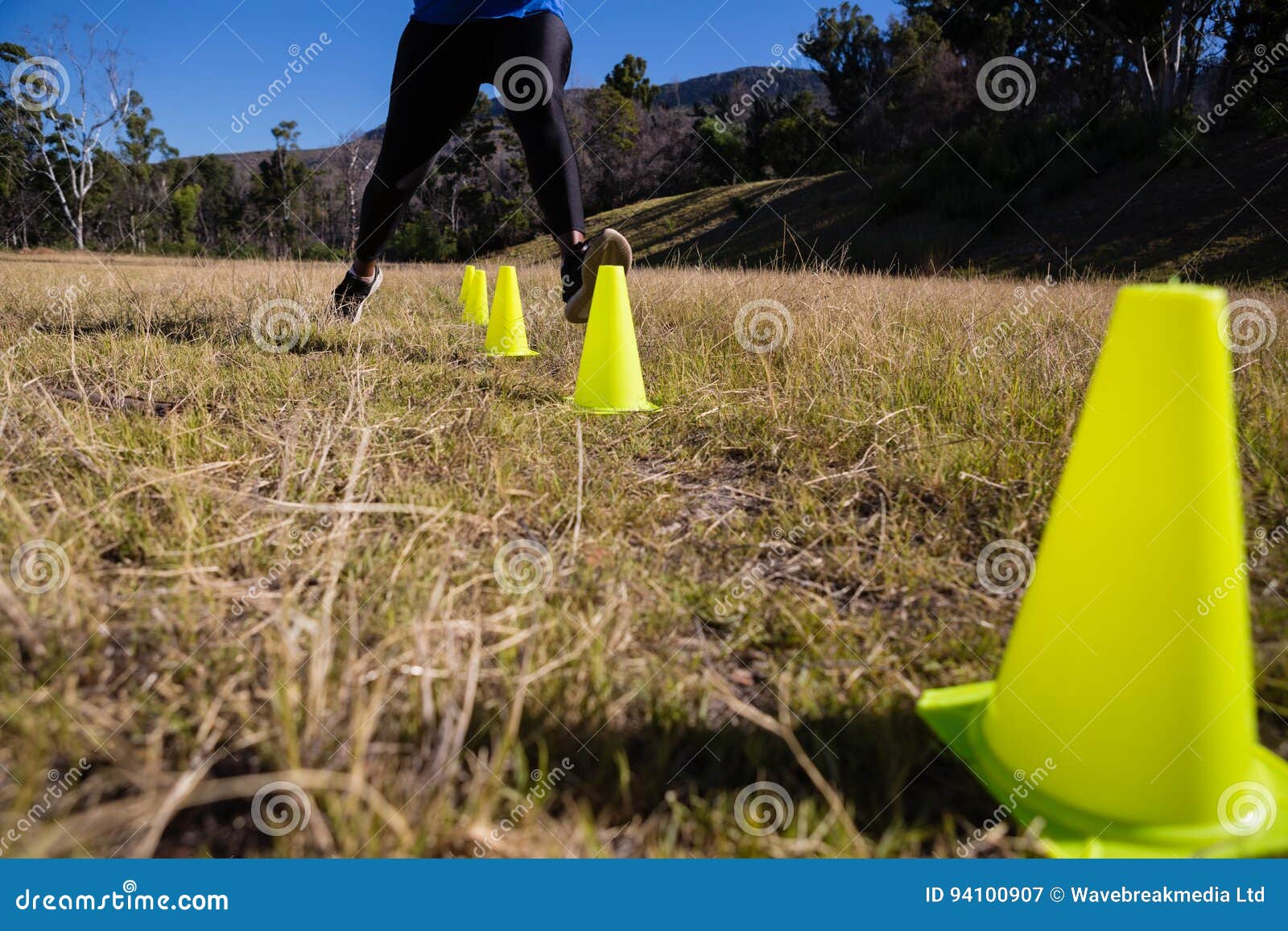 Low-section of Woman Running through Training Cones Stock Image - Image ...