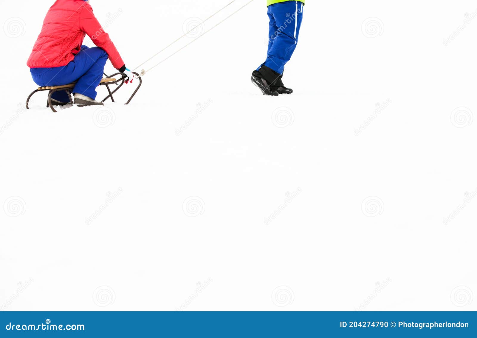 Low Section of Young Man Pulling Woman on Sled Stock Photo - Image of ...