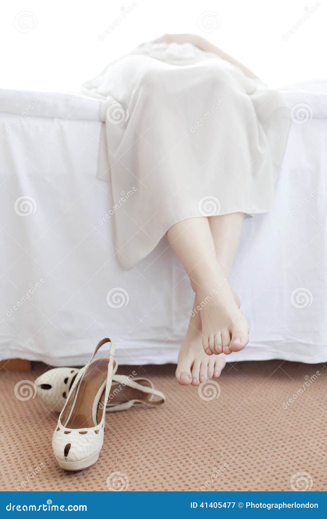 Low Section of Young Woman Lying in Bed with Shoes on Floor Stock Image ...
