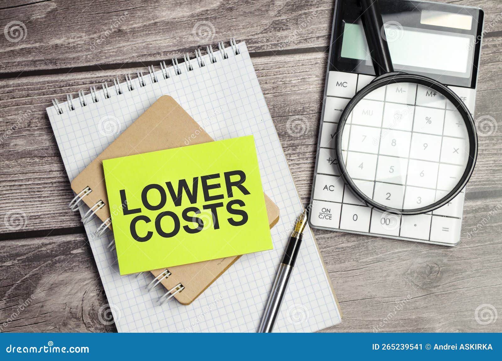 LOWER COSTS Wording on a Green Sticker and Notepad Stock Image - Image ...