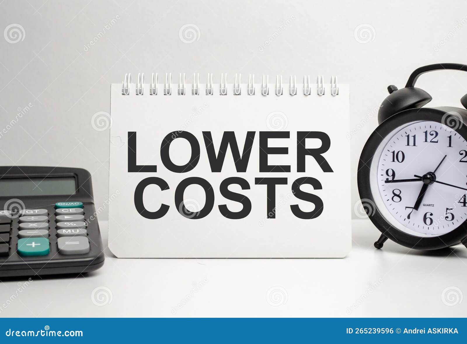 LOWER COSTS Words with Calculator and Clock with Notebook Stock ...