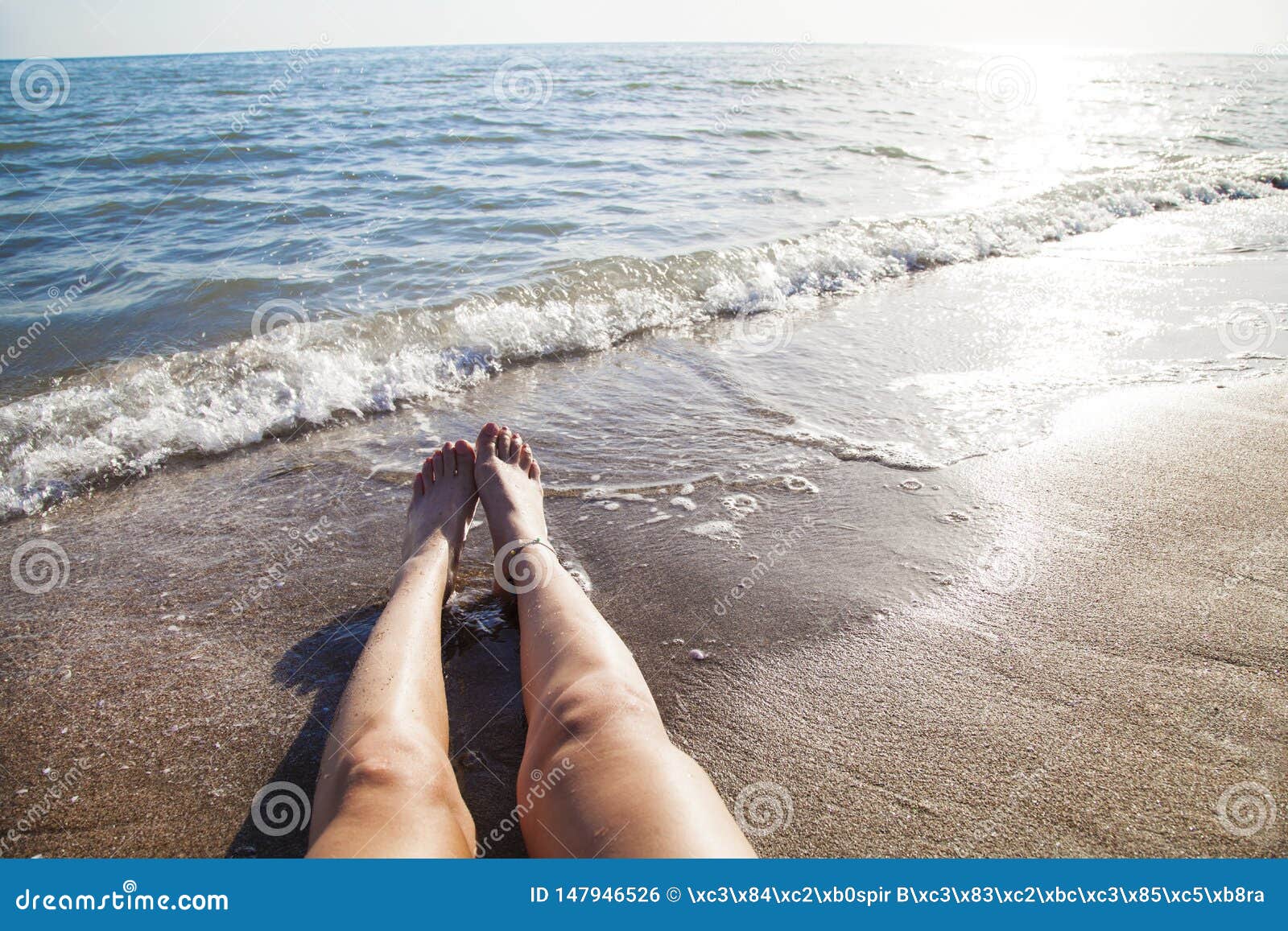 Lower Half of the Girl Body Lying on the Beach by the Sea Stock Photo ...