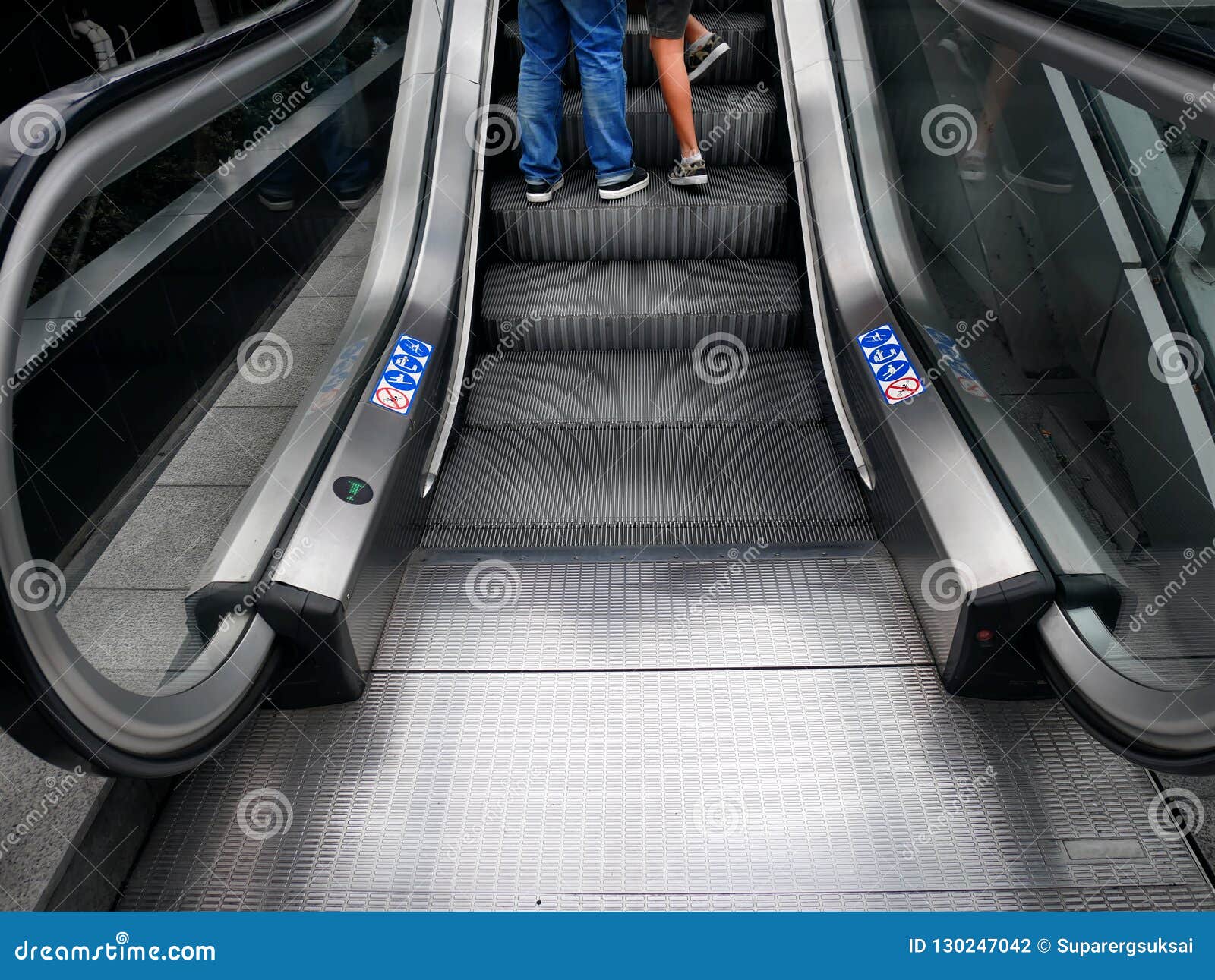Lower Section of People Using Escalator at the Shopping Mall Stock ...