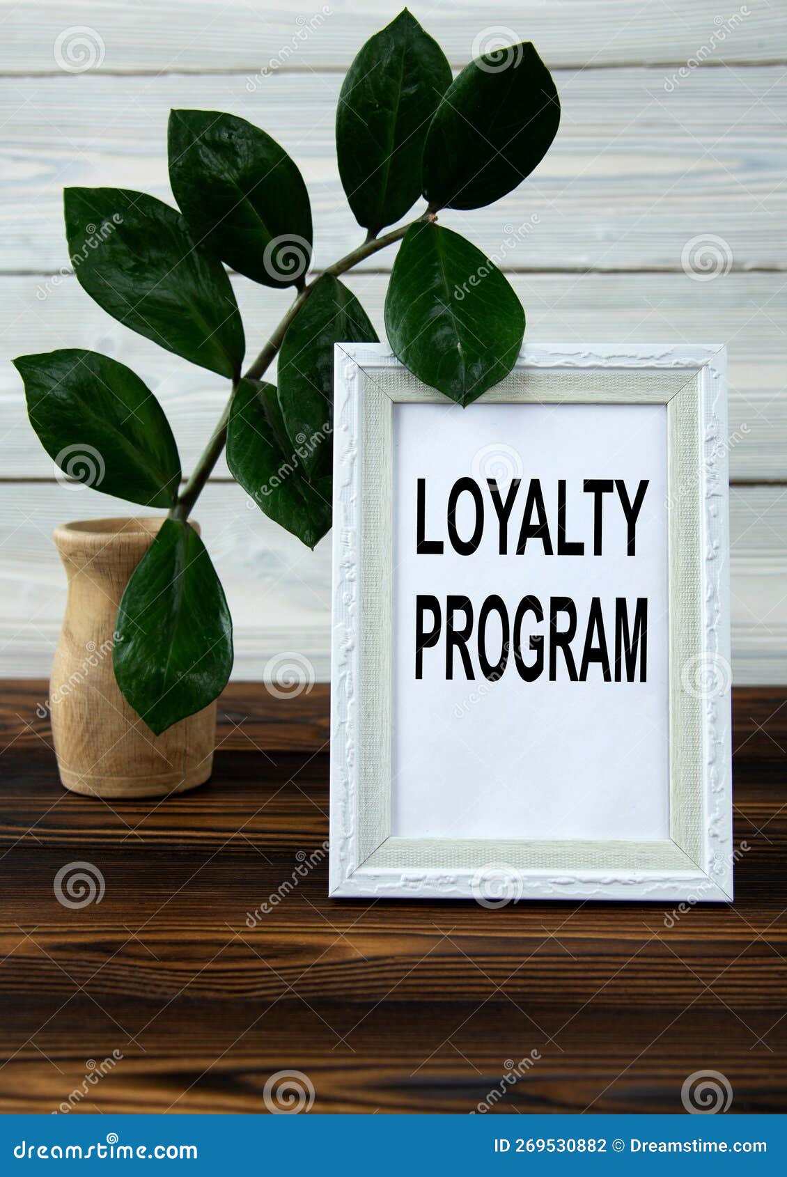 LOYALTY PROGRAM - Words in a White Frame on a Brown Wooden Table with a ...