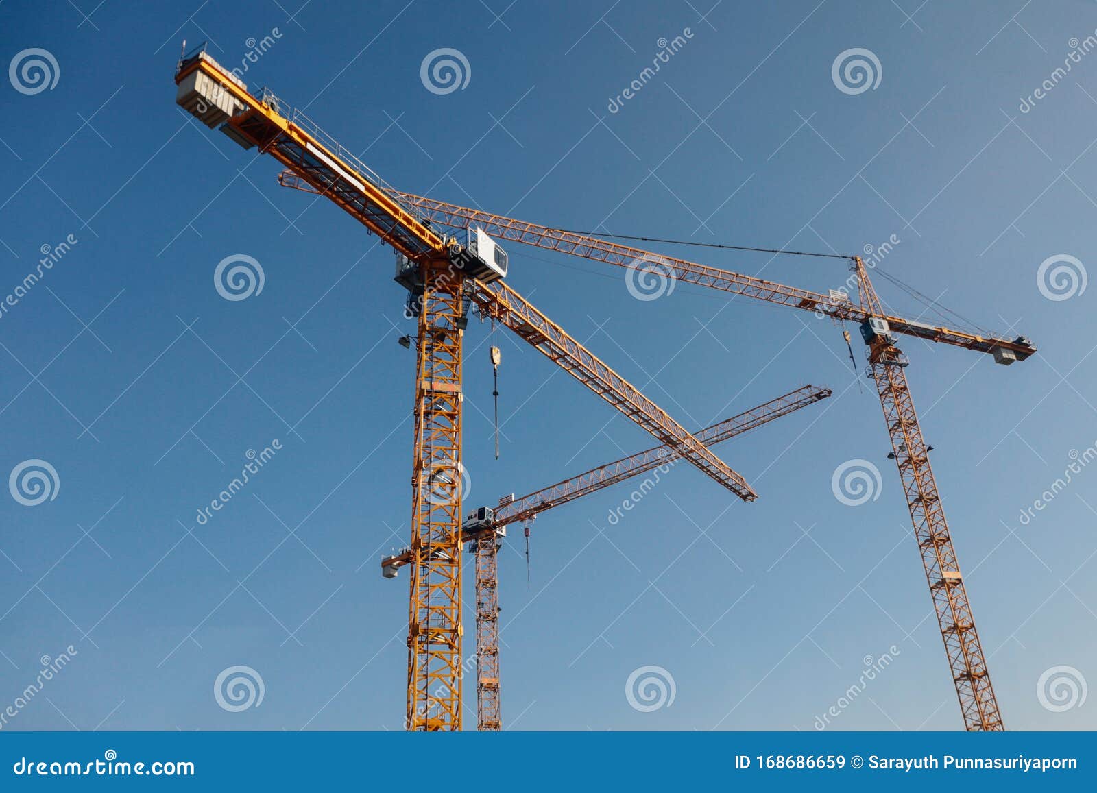 Luffing Jib Tower Crane at Large Scale Construction Site with Blue Sky ...