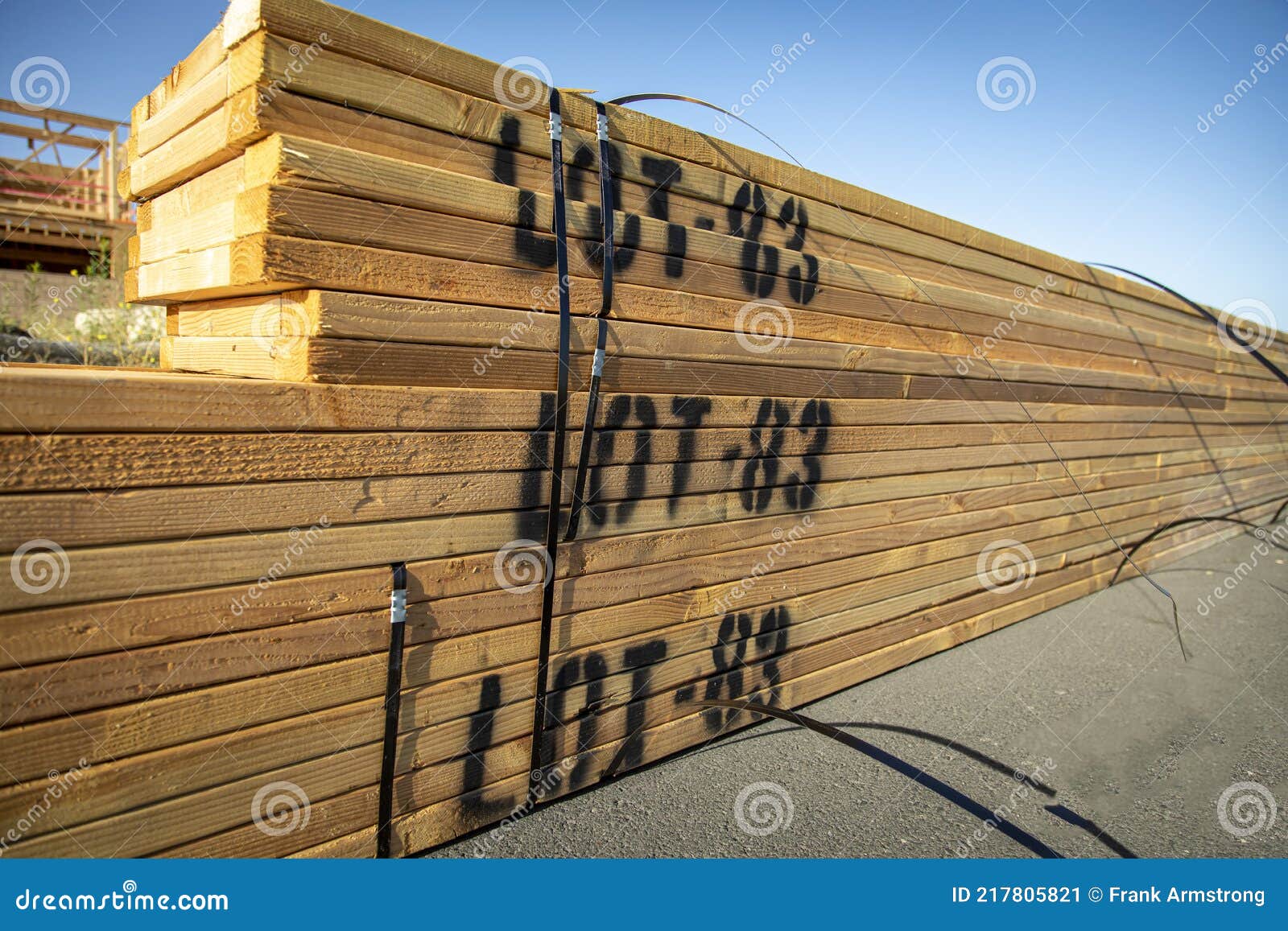 Lumber Stacked at a Housing Construction Site with Framed Structures in ...