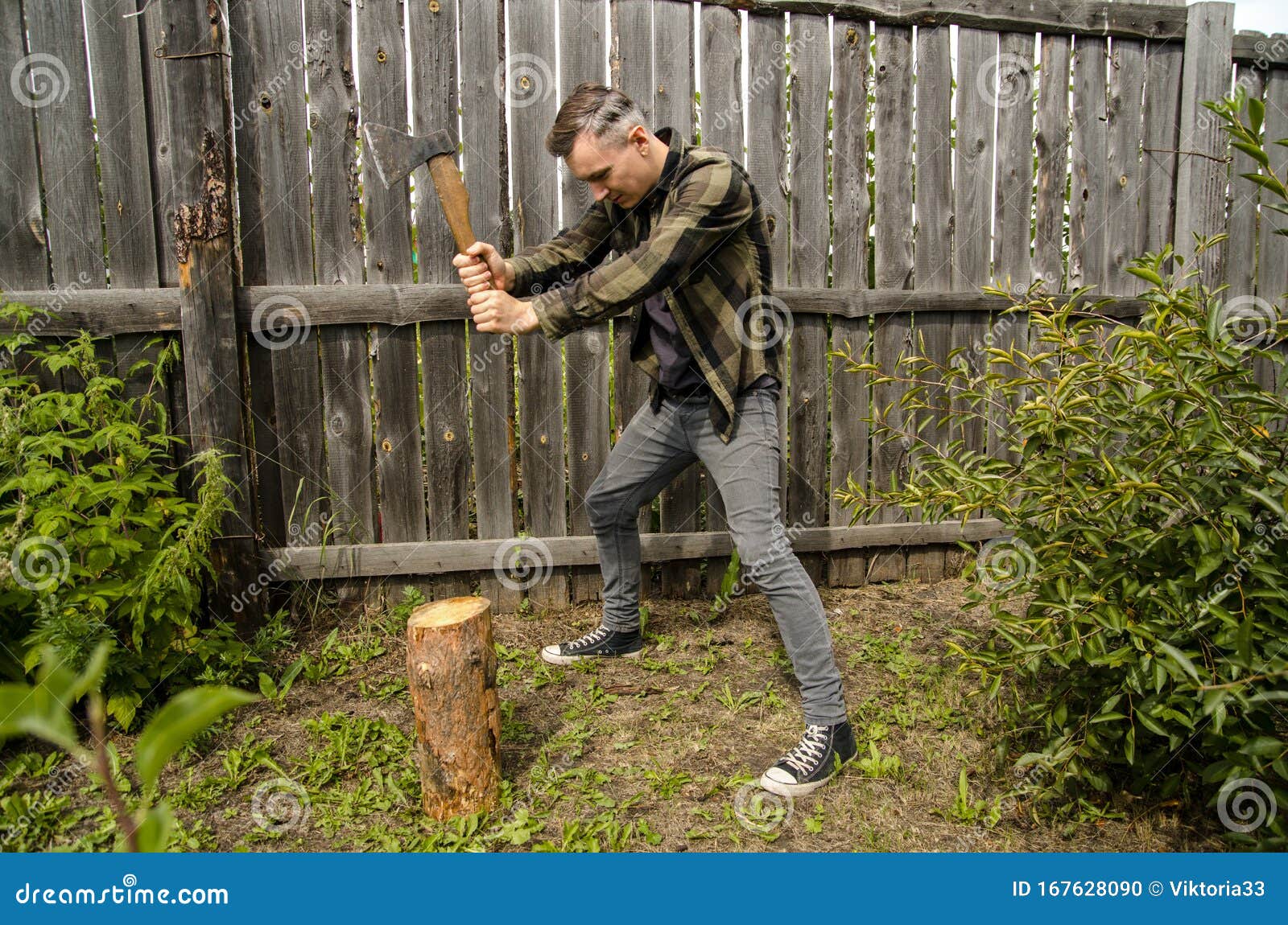 Lumberjack Chopping Wood. Young Man Chopping Woods with an Axe Stock ...