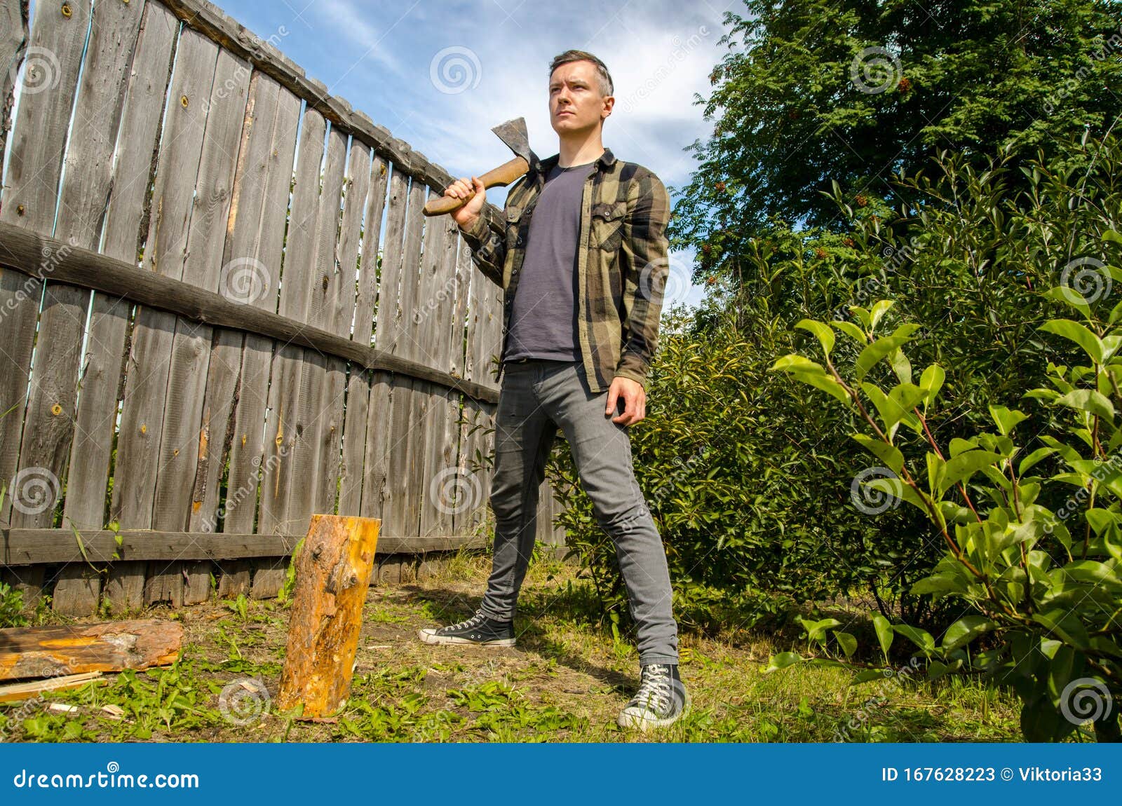 Lumberjack Chopping Wood. Young Man Chopping Woods with an Axe Stock ...