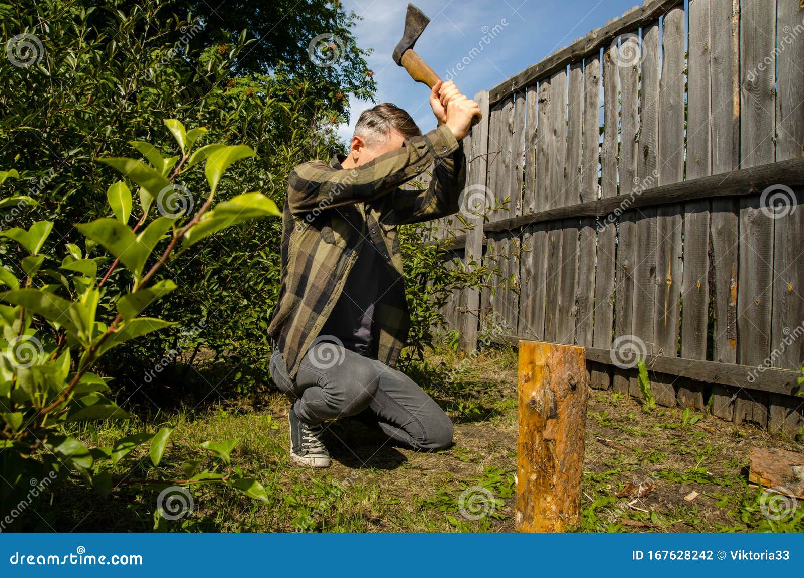 Lumberjack Chopping Wood. Young Man Chopping Woods with an Axe Stock ...