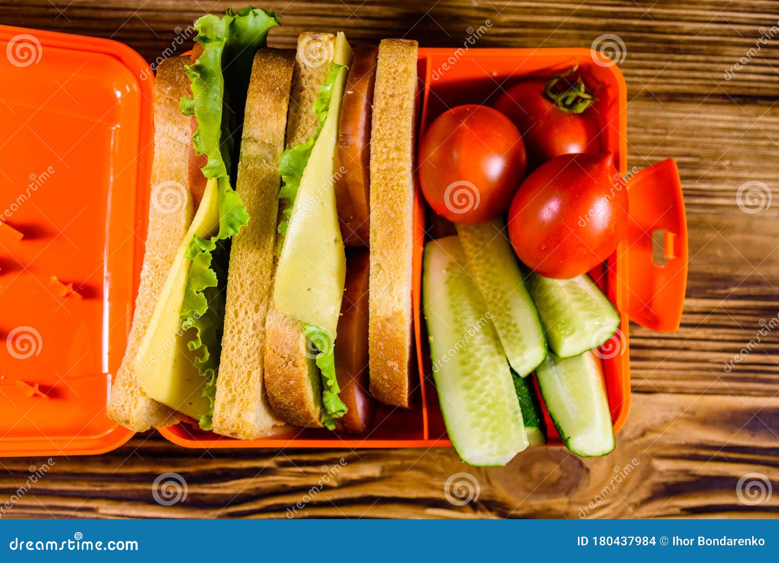 Lunch Box with Sandwiches, Cucumbers and Tomatoes on Wooden Table. Top ...