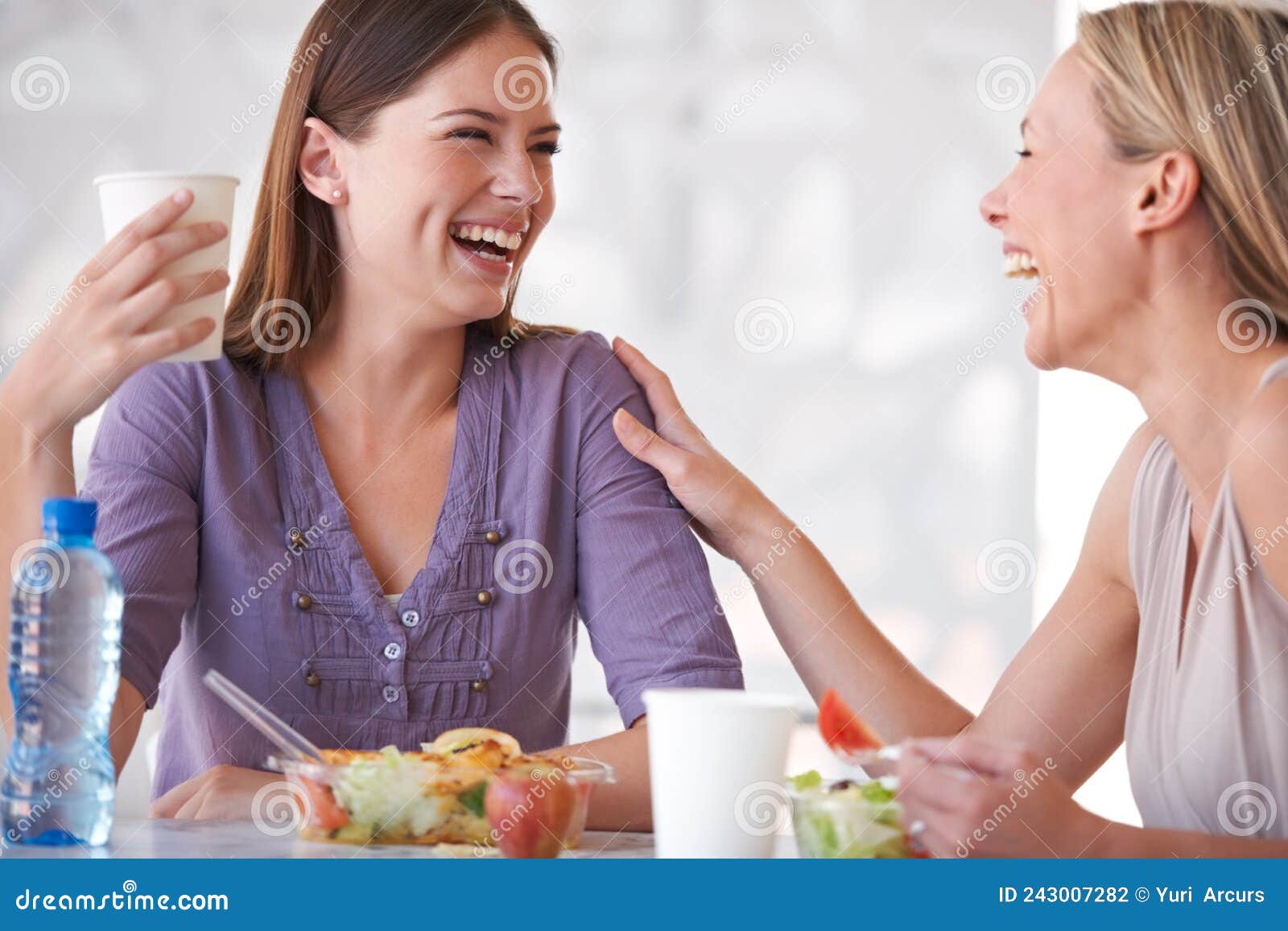 Lunch Break Bonding. Shot of Two Colleagues Having Lunch Together ...