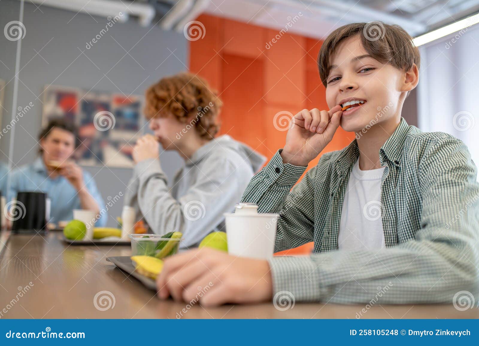 A Teacher and His Students Having Lunch at School Canteen Stock Photo ...