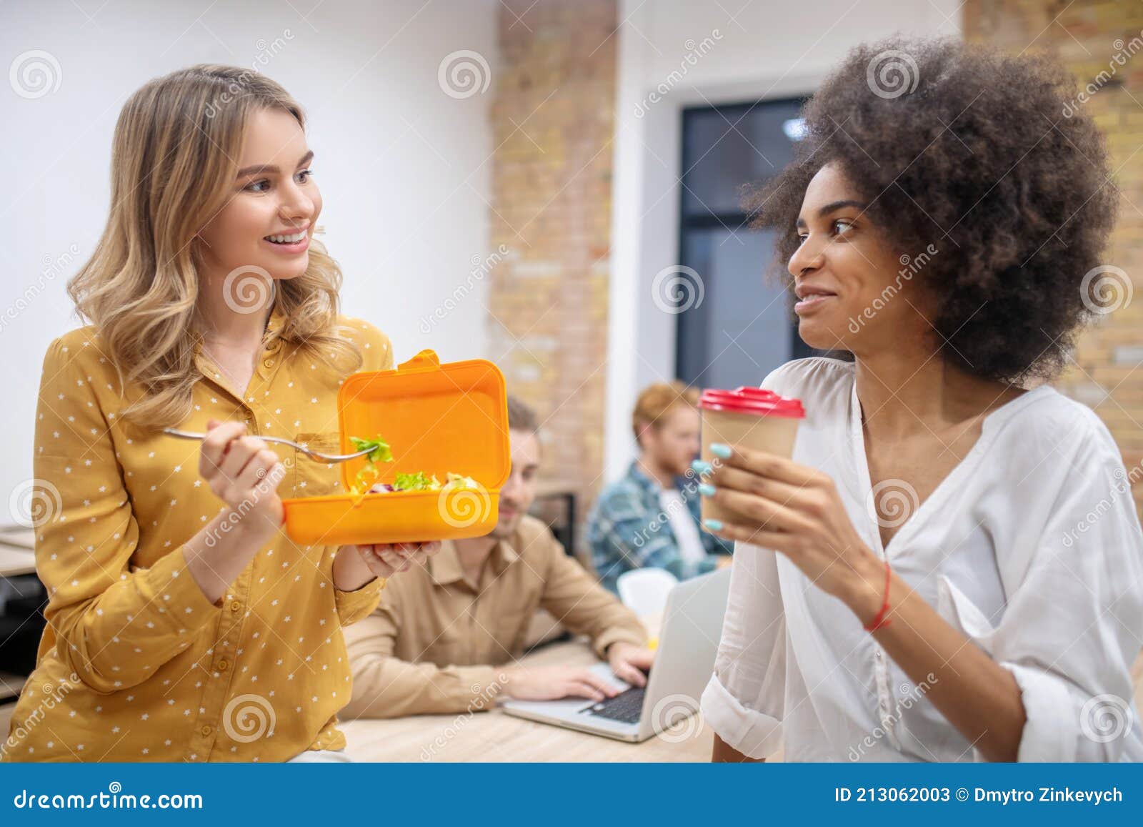 Two Female Colleagues Eating Lunch Together and Talking Stock Image ...