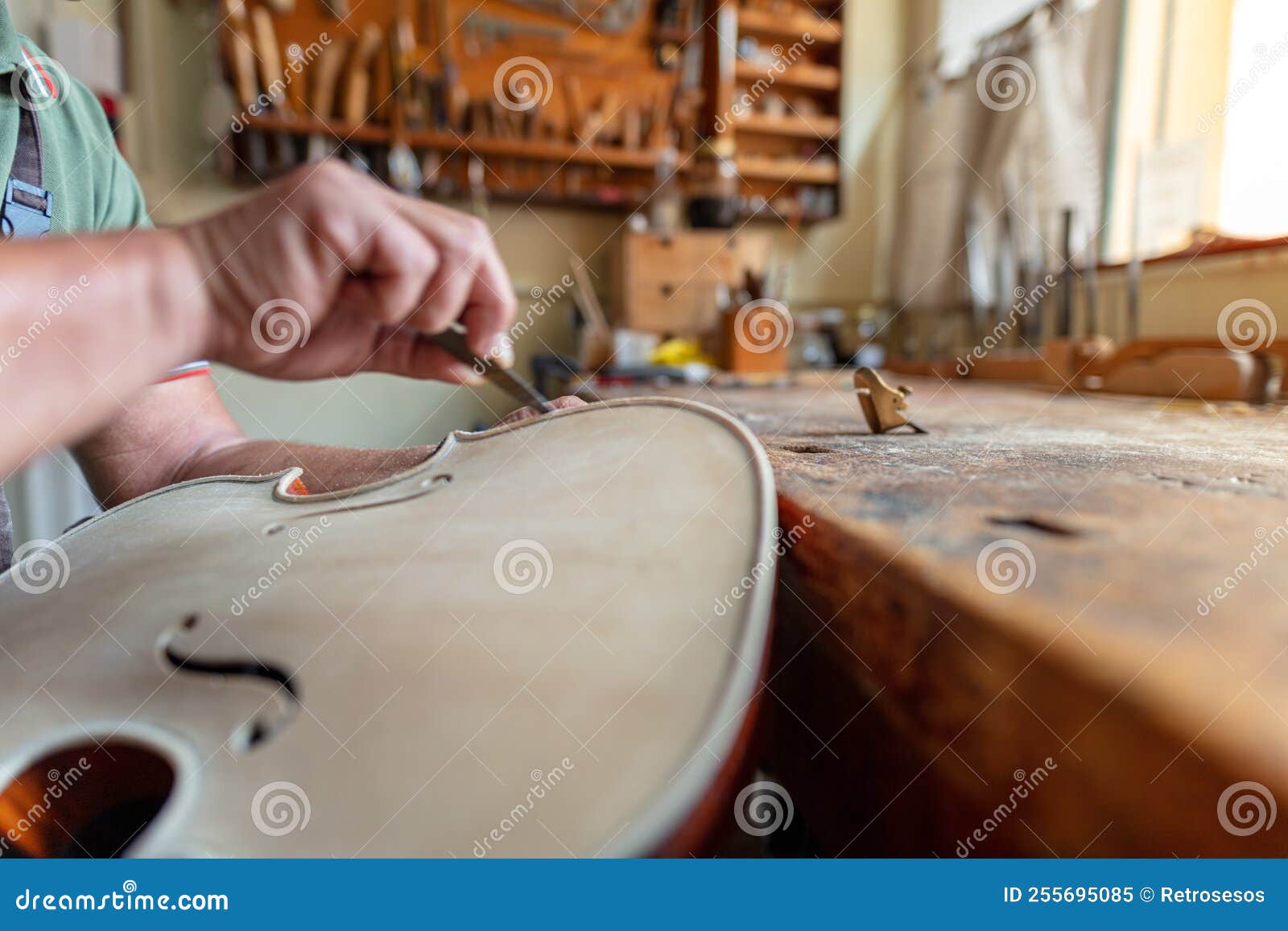 Luthier Carving the Shape of the Outside of the Front of a Violin with ...