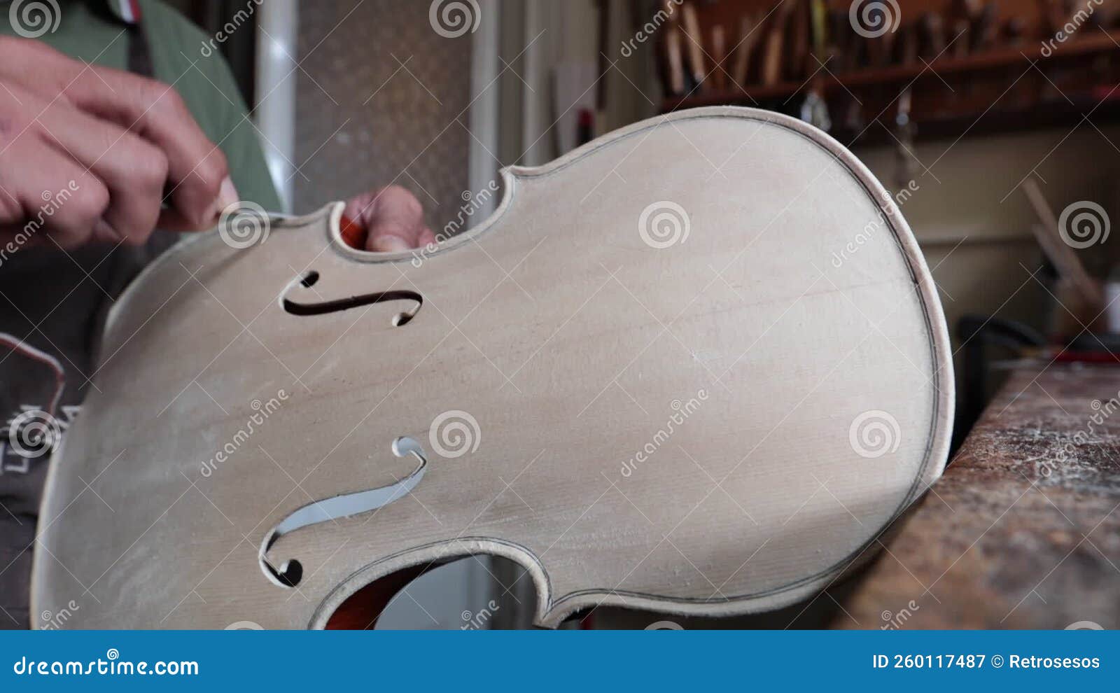 Luthier Carving the Shape of the Outside of the Front of a Violin with ...