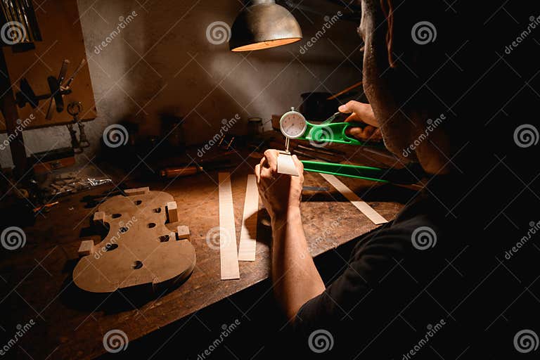 Luthier using his tools stock photo. Image of measuring - 338543318