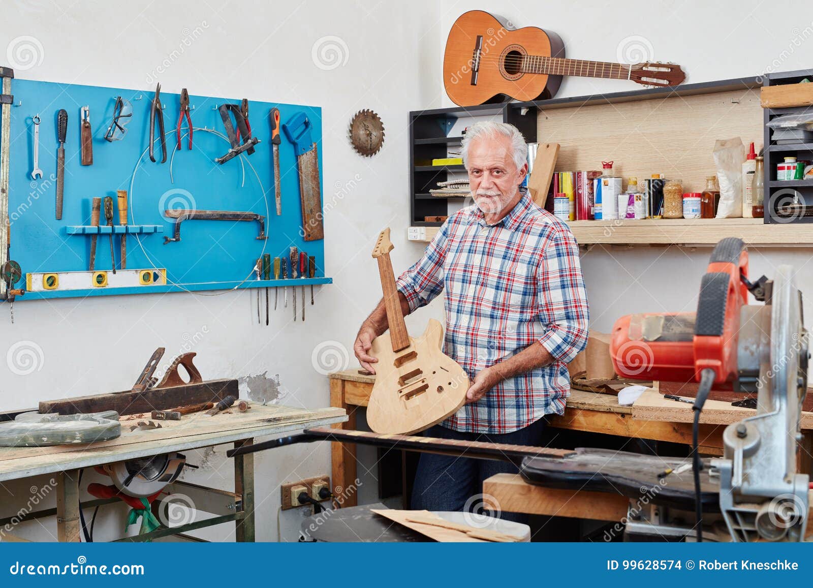 Luthier showing new guitar stock photo. Image of assemble - 99628574