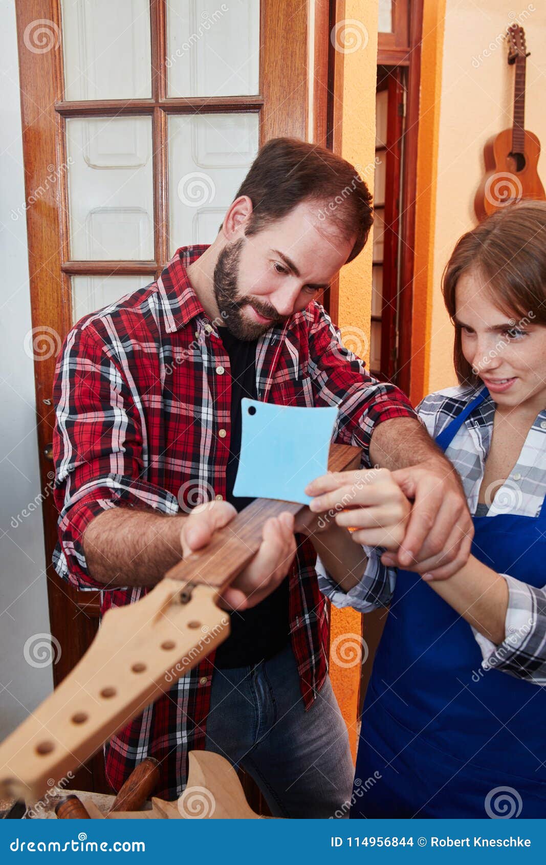 Luthier teaches apprentice stock photo. Image of blue - 114956844